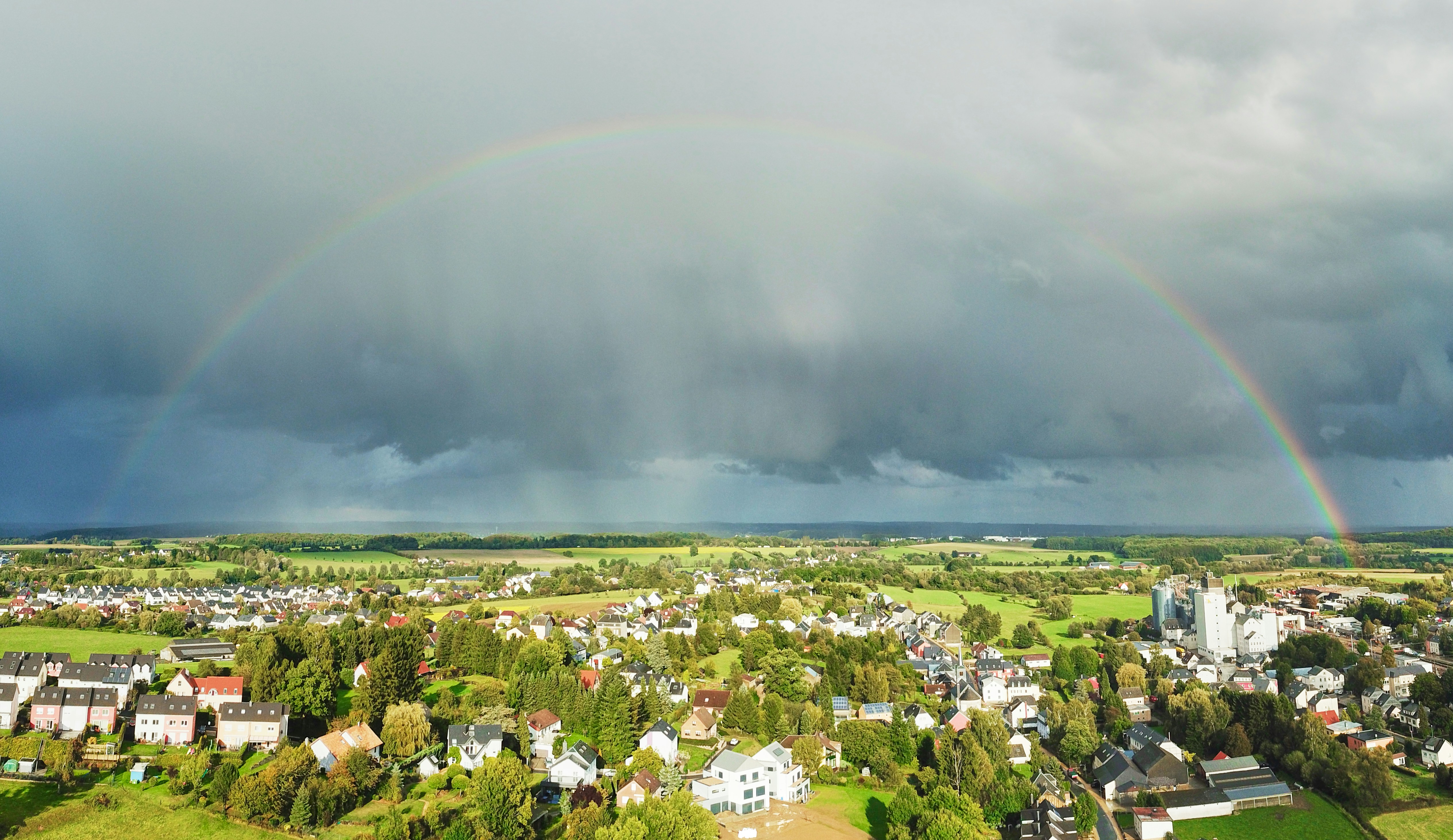 Rainbow Arc Over a Quiet Suburban Panorama