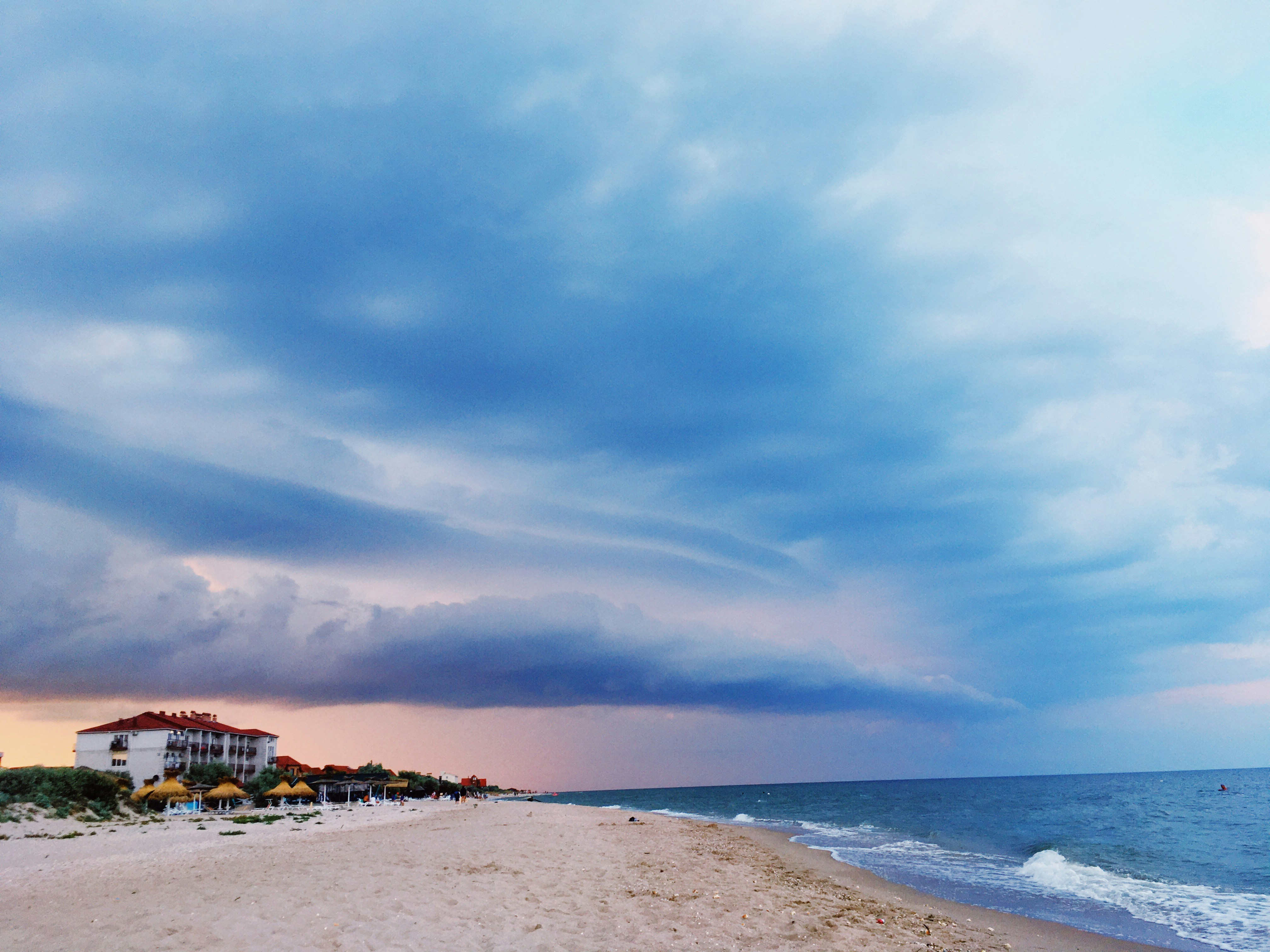 Low Tide Ballet: Beachfront Under a Charged Sky