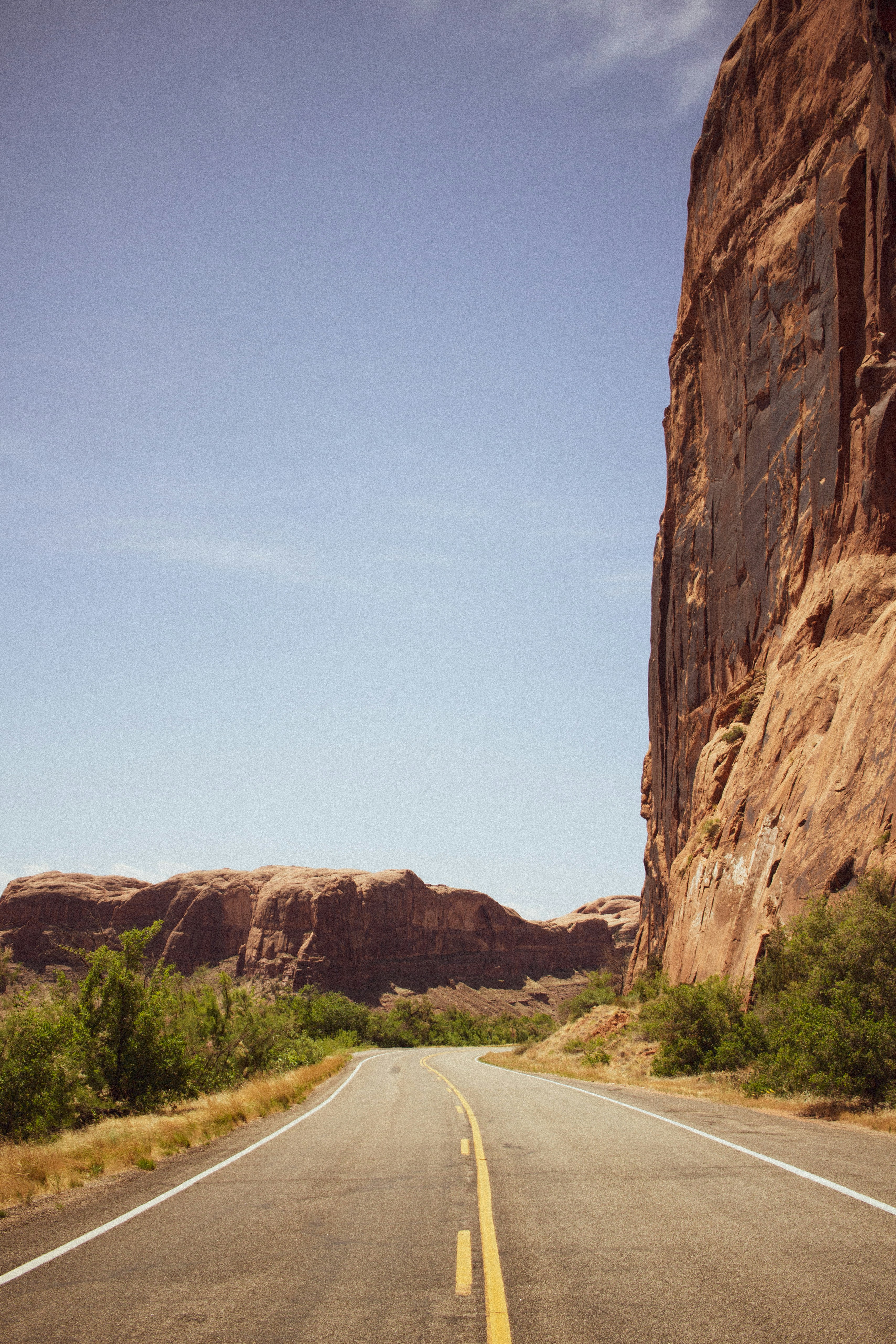 Desert Road Between Giants: A Red-Cliff Corridor Leads the Eye