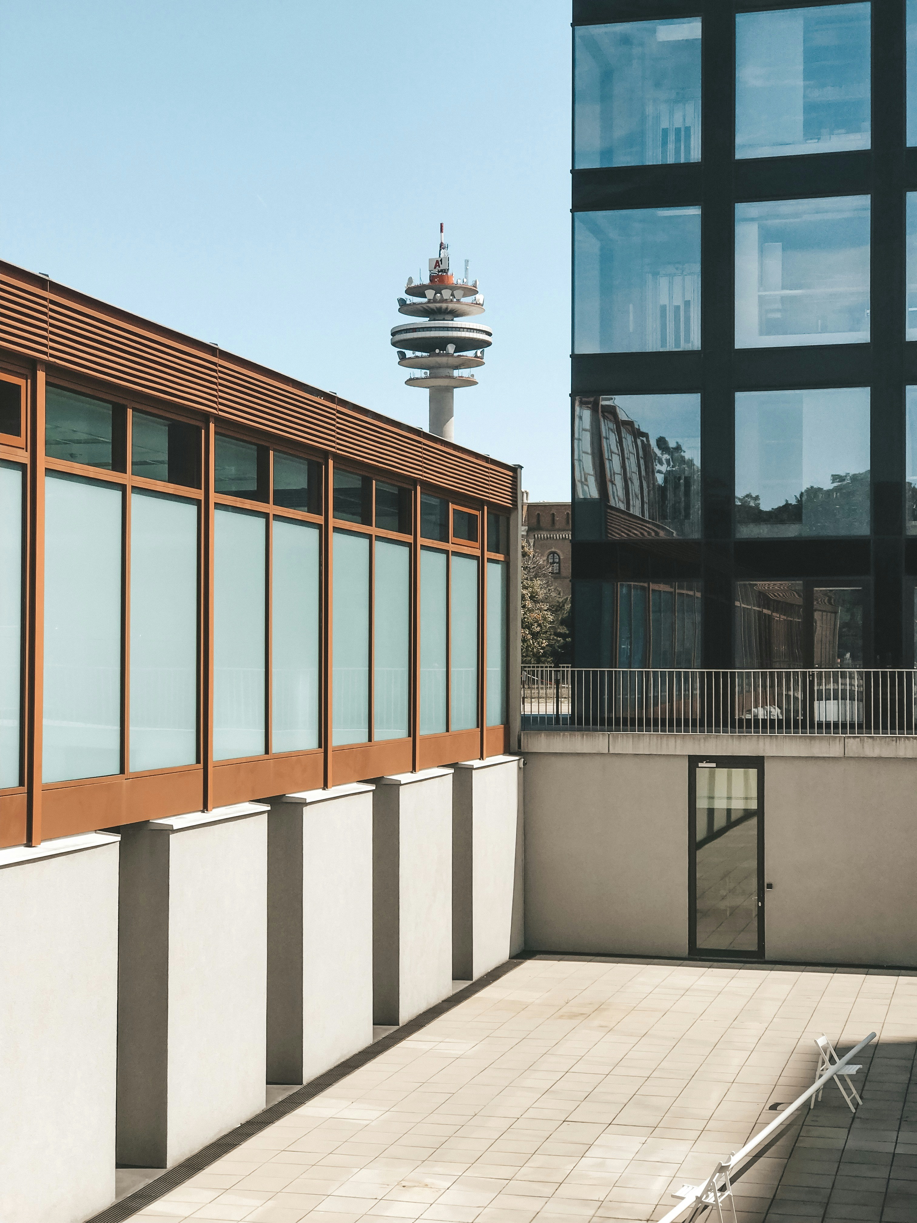 Distant Tower within an Urban Rooftop Frame