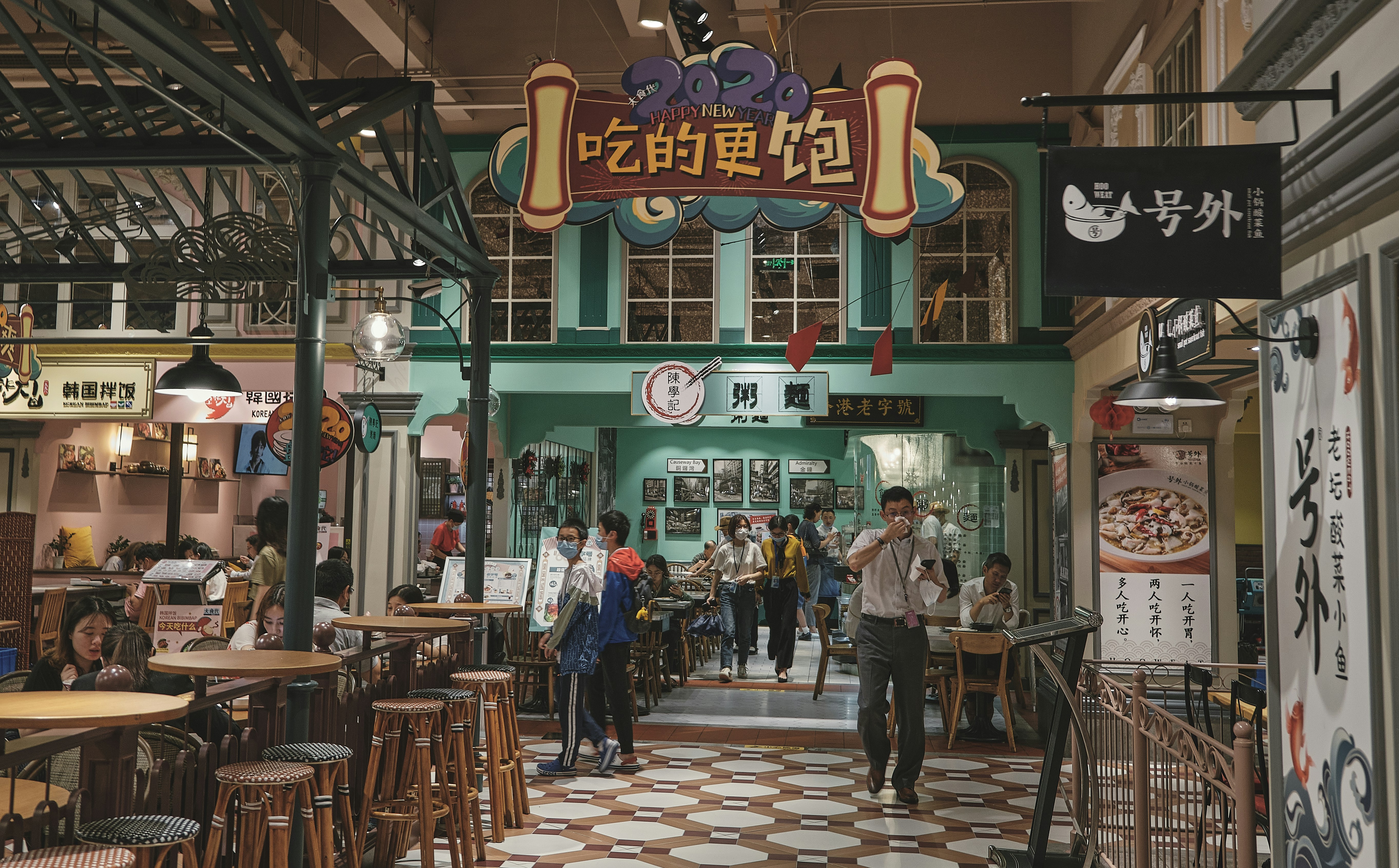 people standing near brown wooden table and chairs