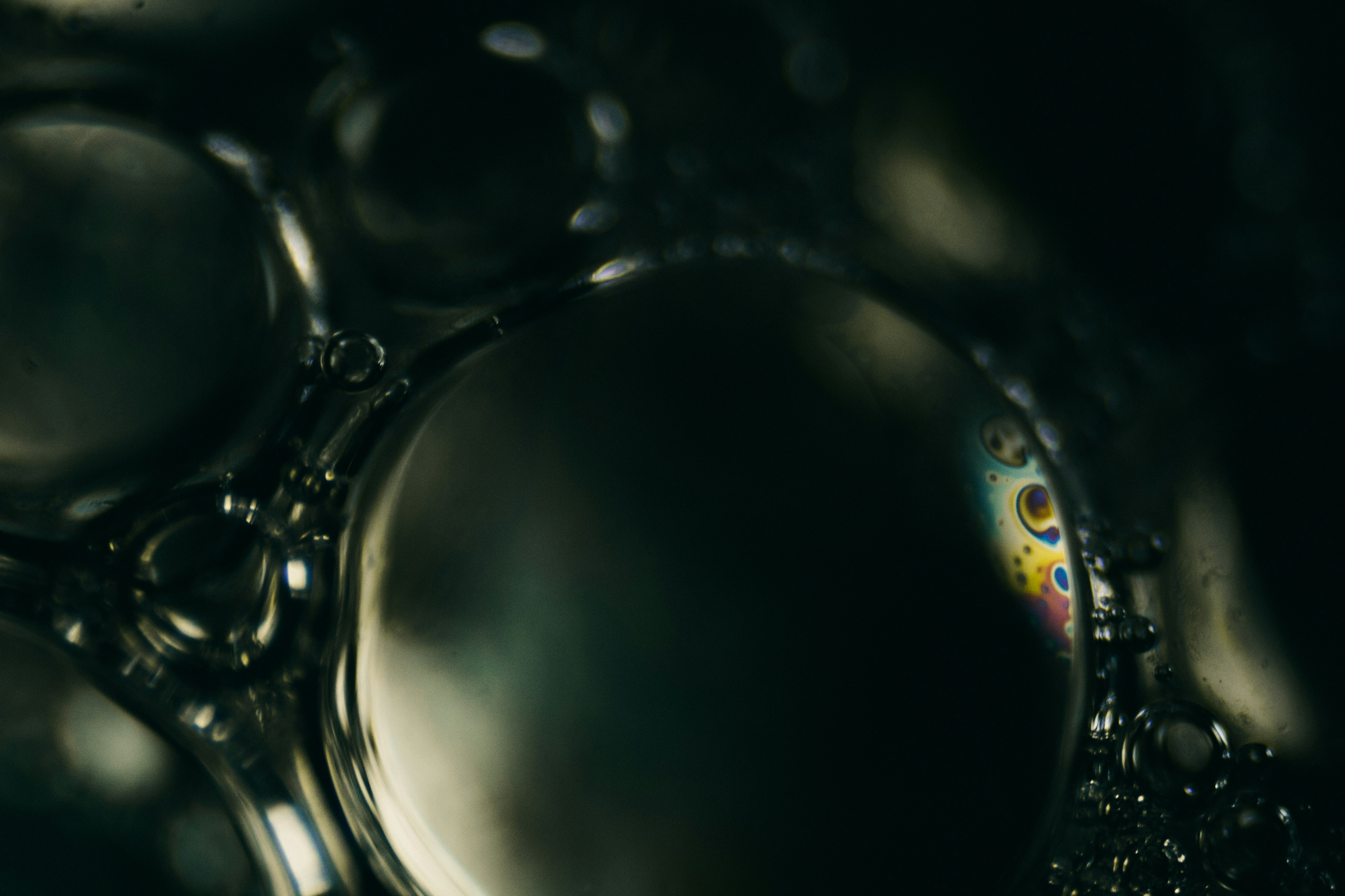 Glass Orbits in the Dark: A Macro Portrait of Bubbles