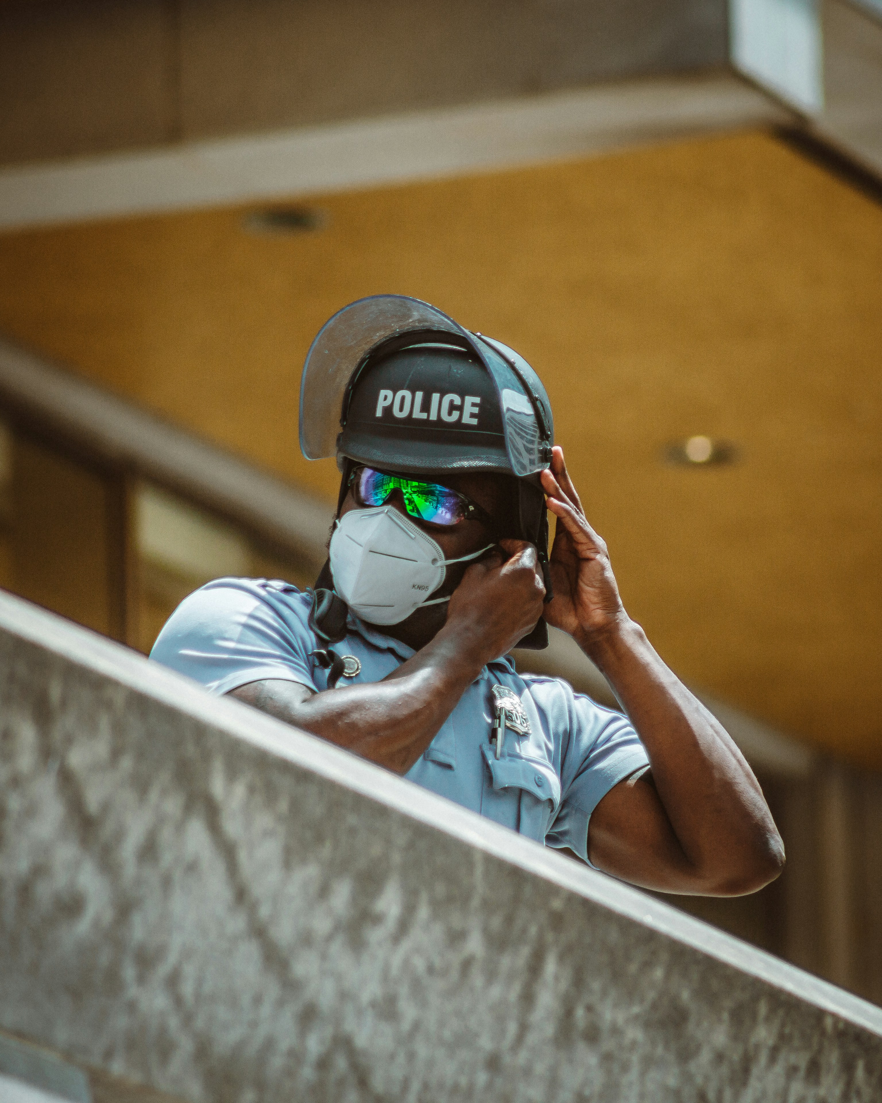 Under the Helmet: A Police Officer on a Concrete Stairwell