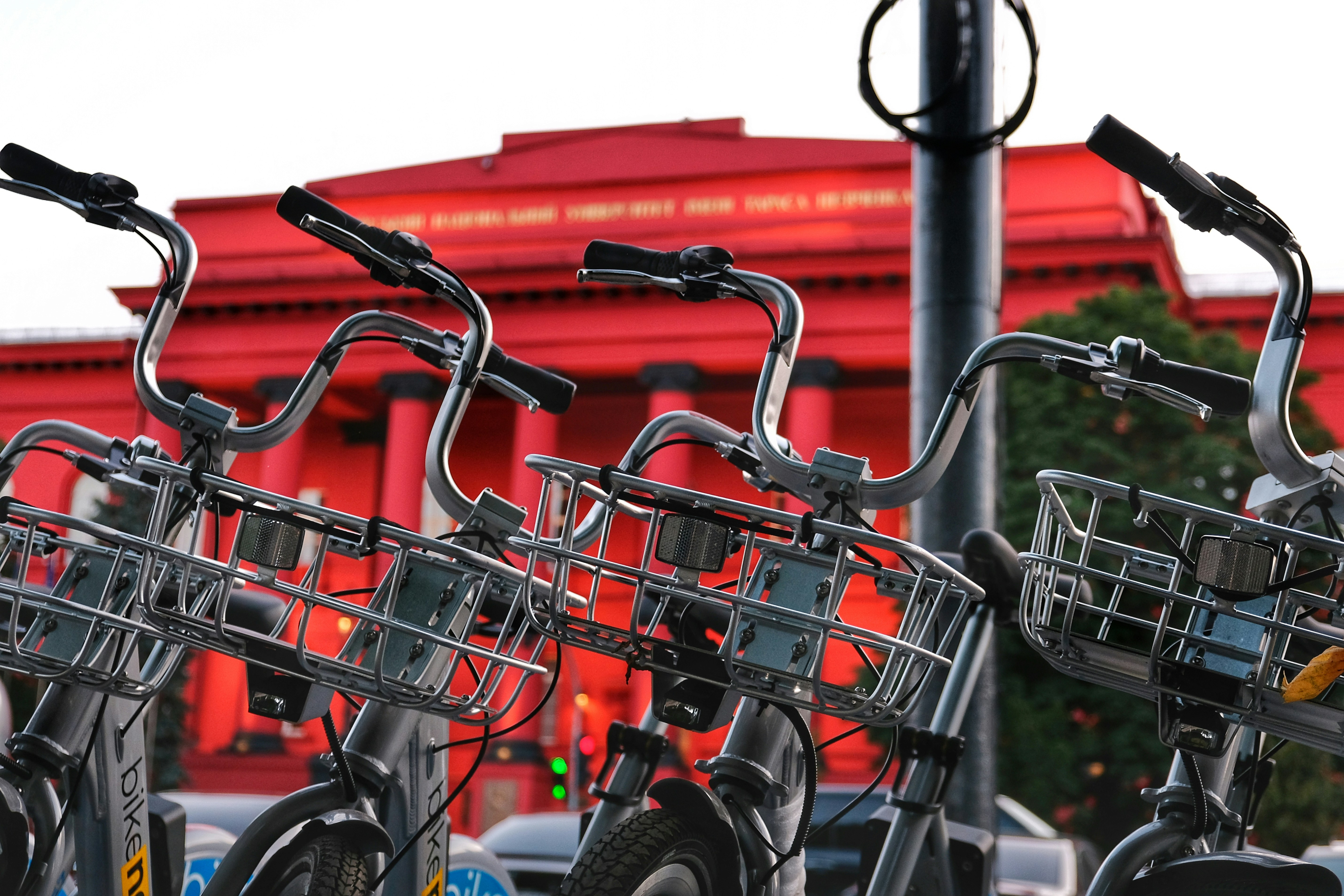 Bikes in Line, Framed by a Crimson Gate