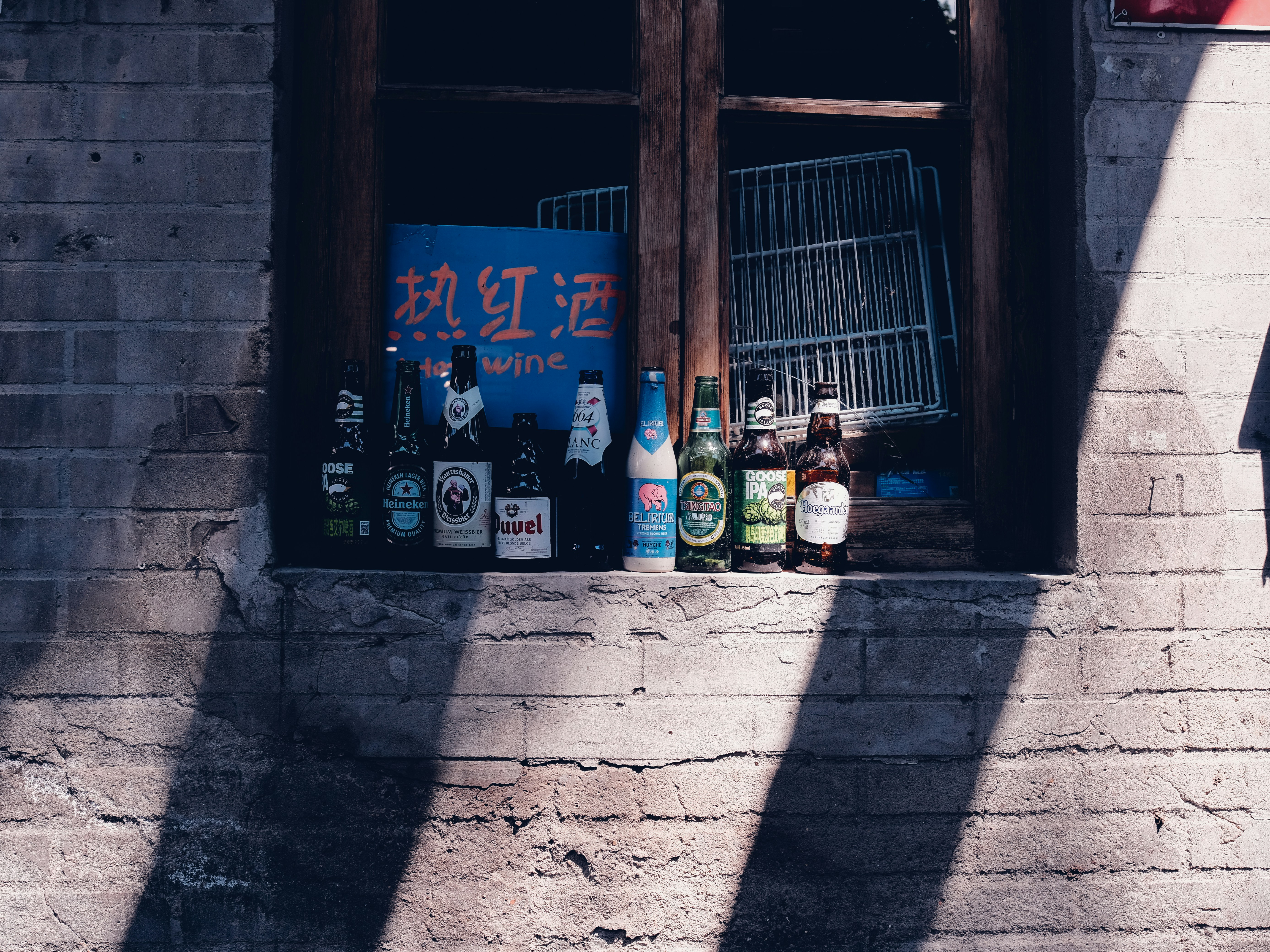 Sunlit Mendicant Bottles: A Window Shelf of Nightlife