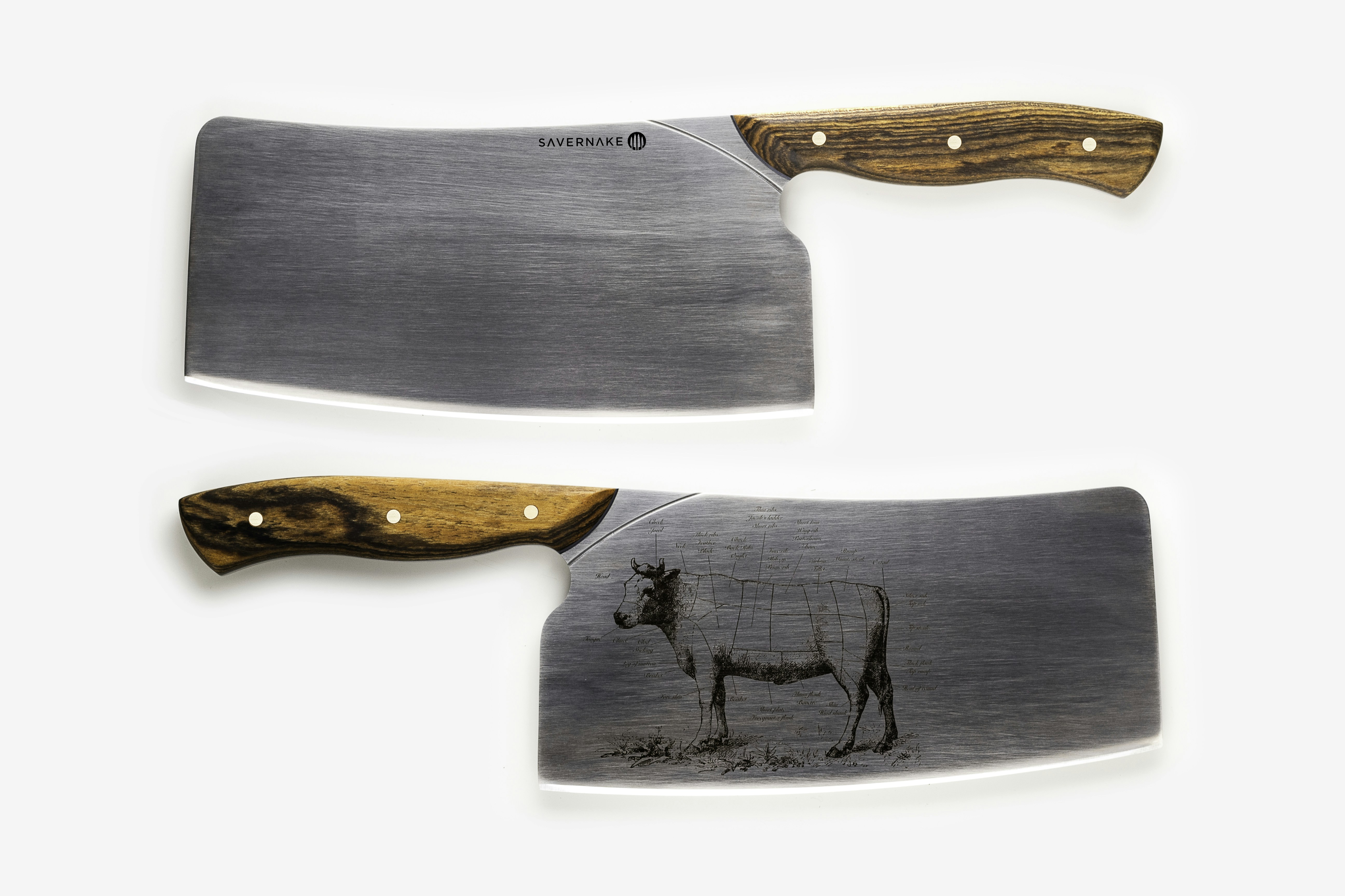 Two cleavers with distinct designs, one featuring a sleek blade and the other adorned with an engraved cow illustration. Perfect for culinary enthusiasts.