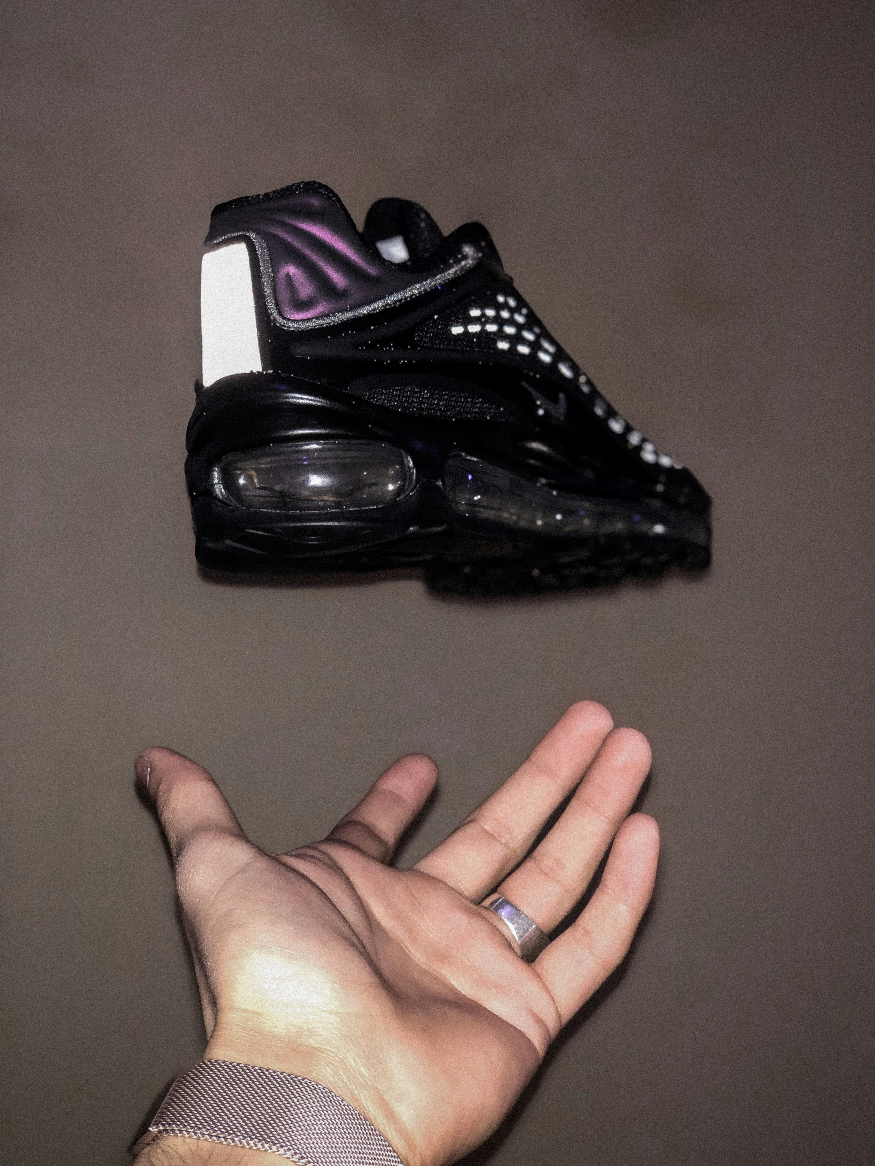Hovering Sneaker Above an Open Palm