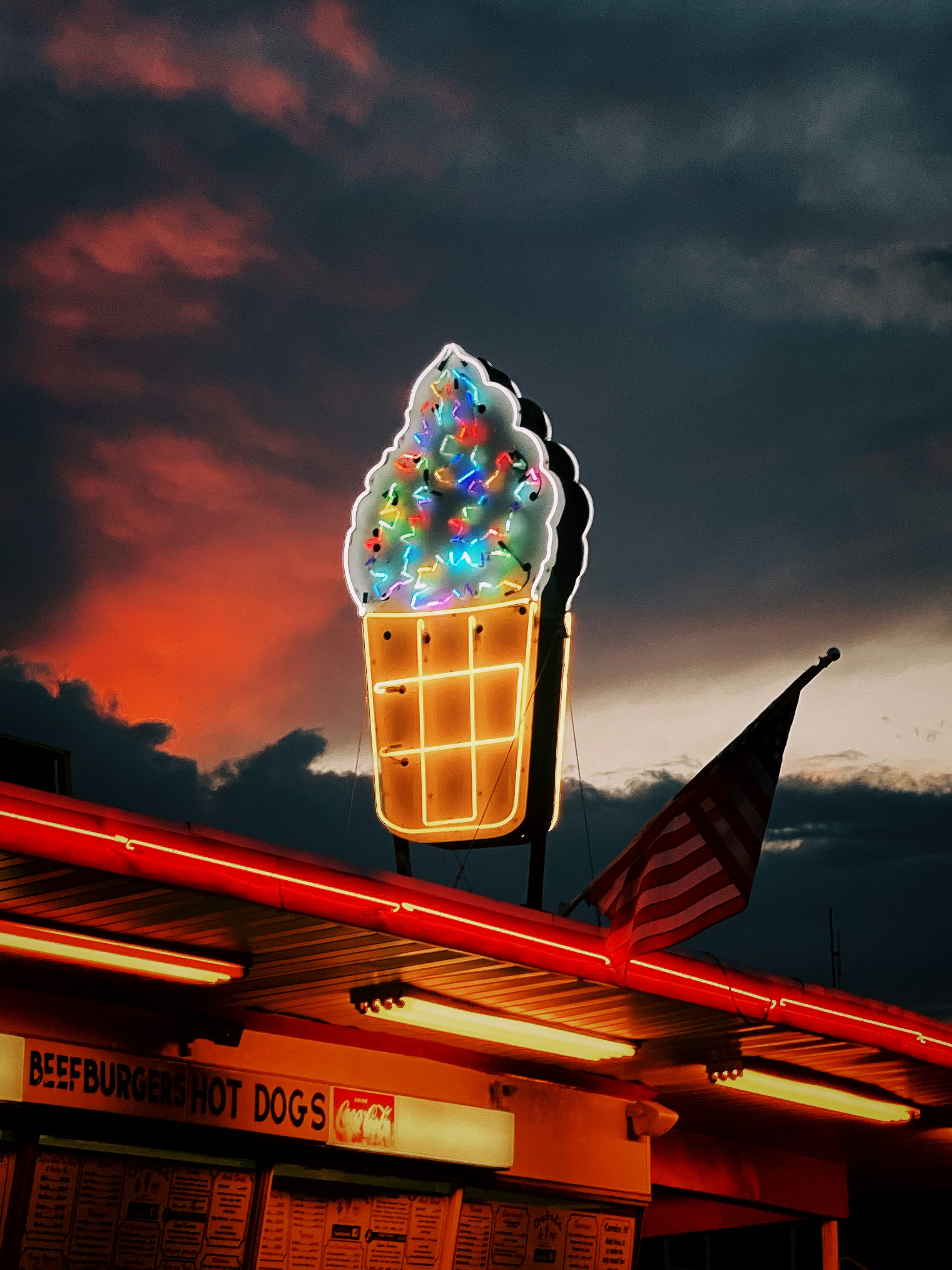 Neon Ice Cream Cone Soars Above a Sunset Diner
