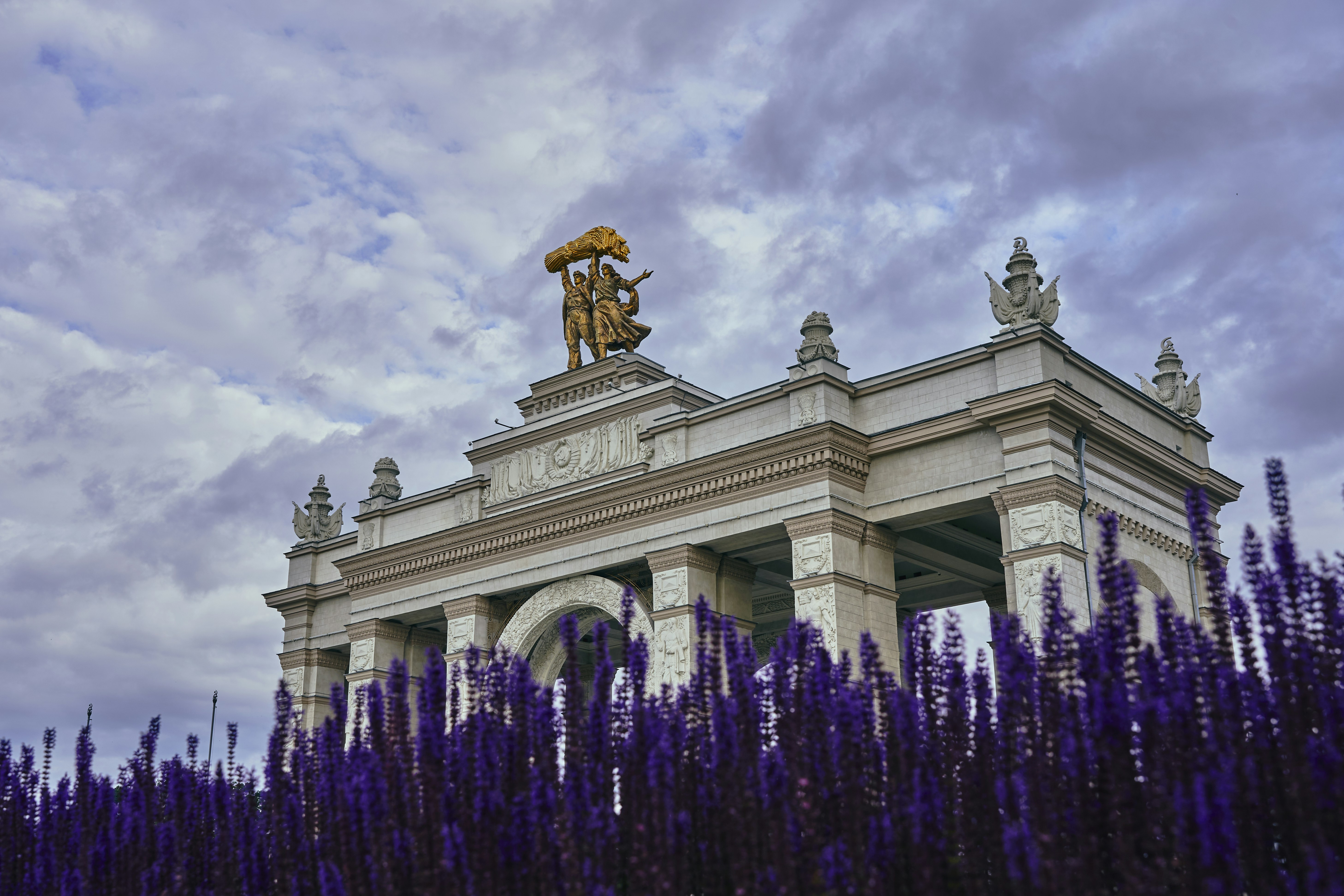 Neoclassical Parapet Crown: Statues Above a Field of Violet Blooms