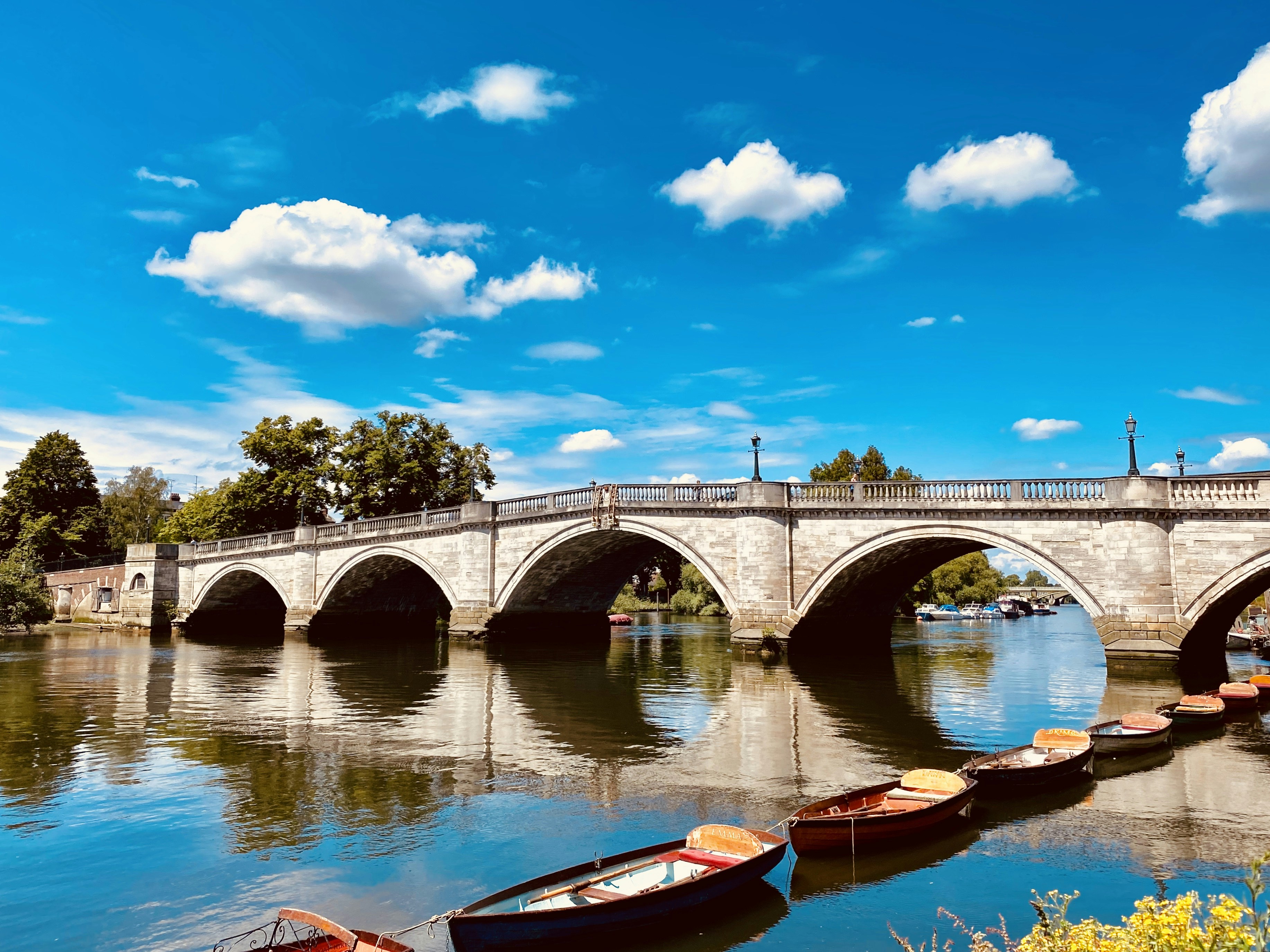 Red and black boat on river under bridge during daytime photo – Free ...