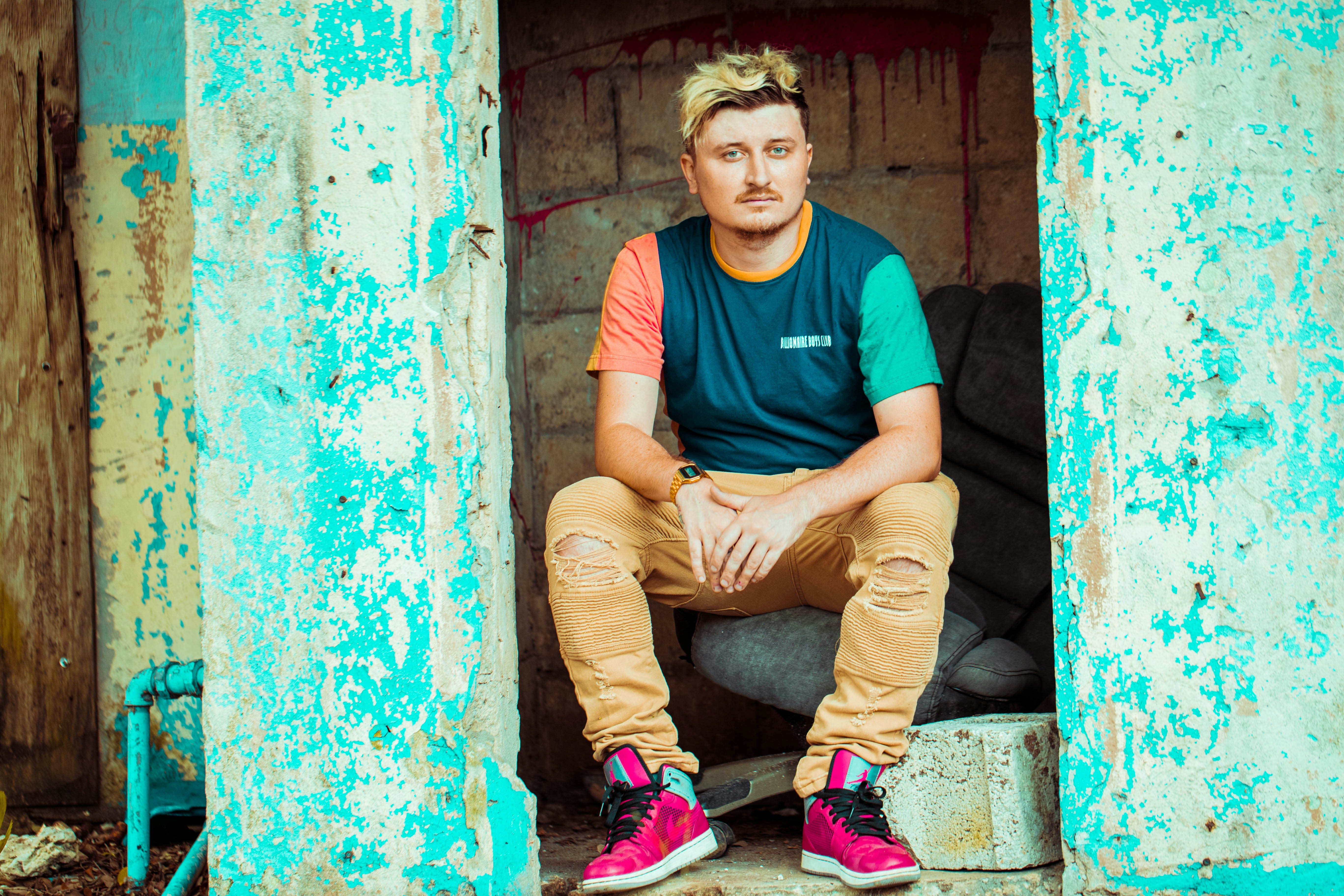 somber looking man with dyed hair