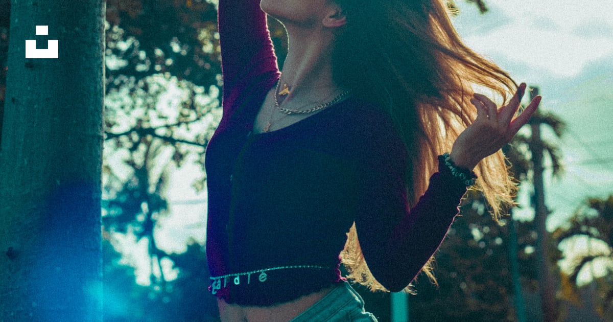 Woman In Black Long Sleeve Shirt And Blue Denim Jeans Standing Beside