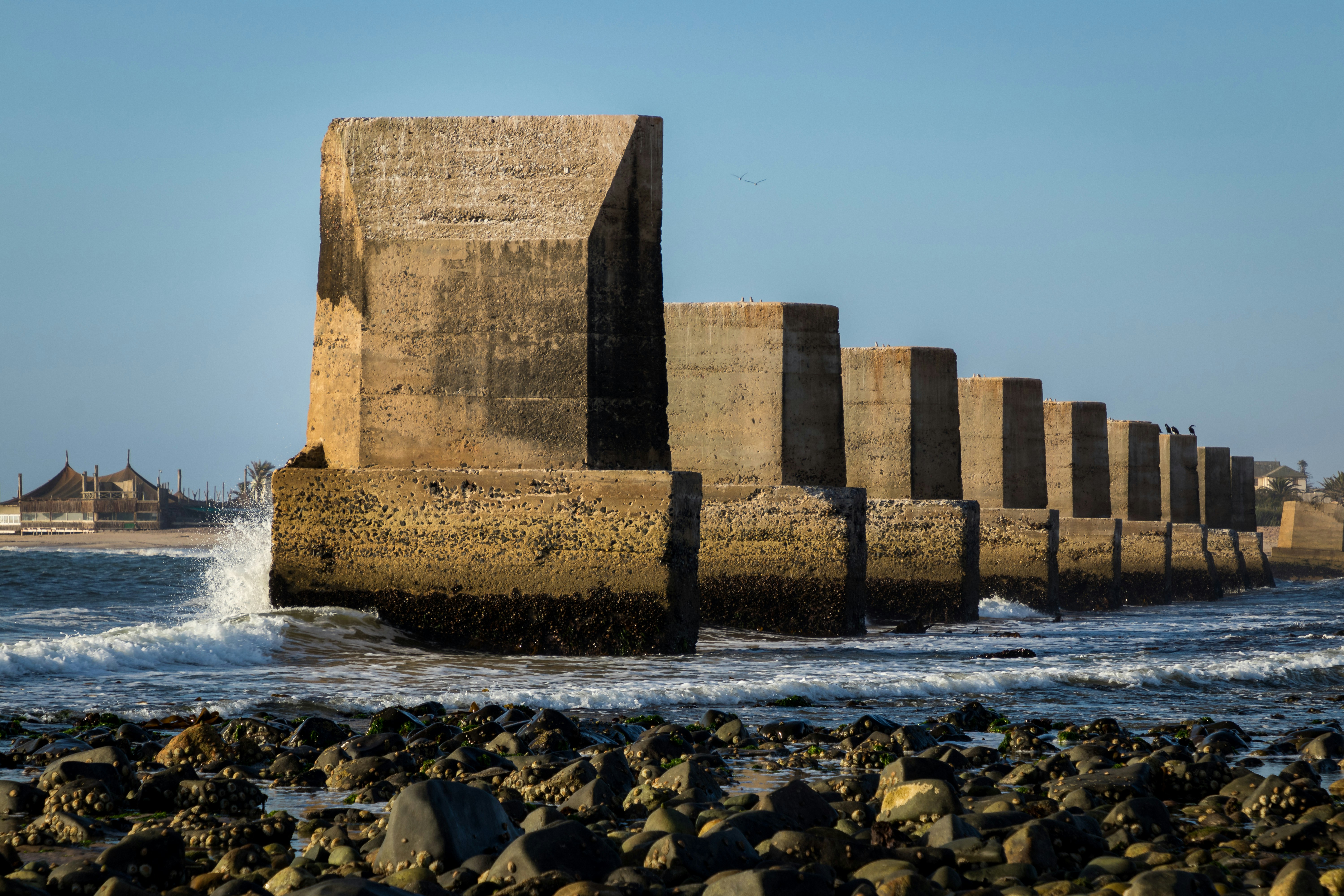 Pillars on the Line: A Coastal Breakwater Reaching Toward the Horizon