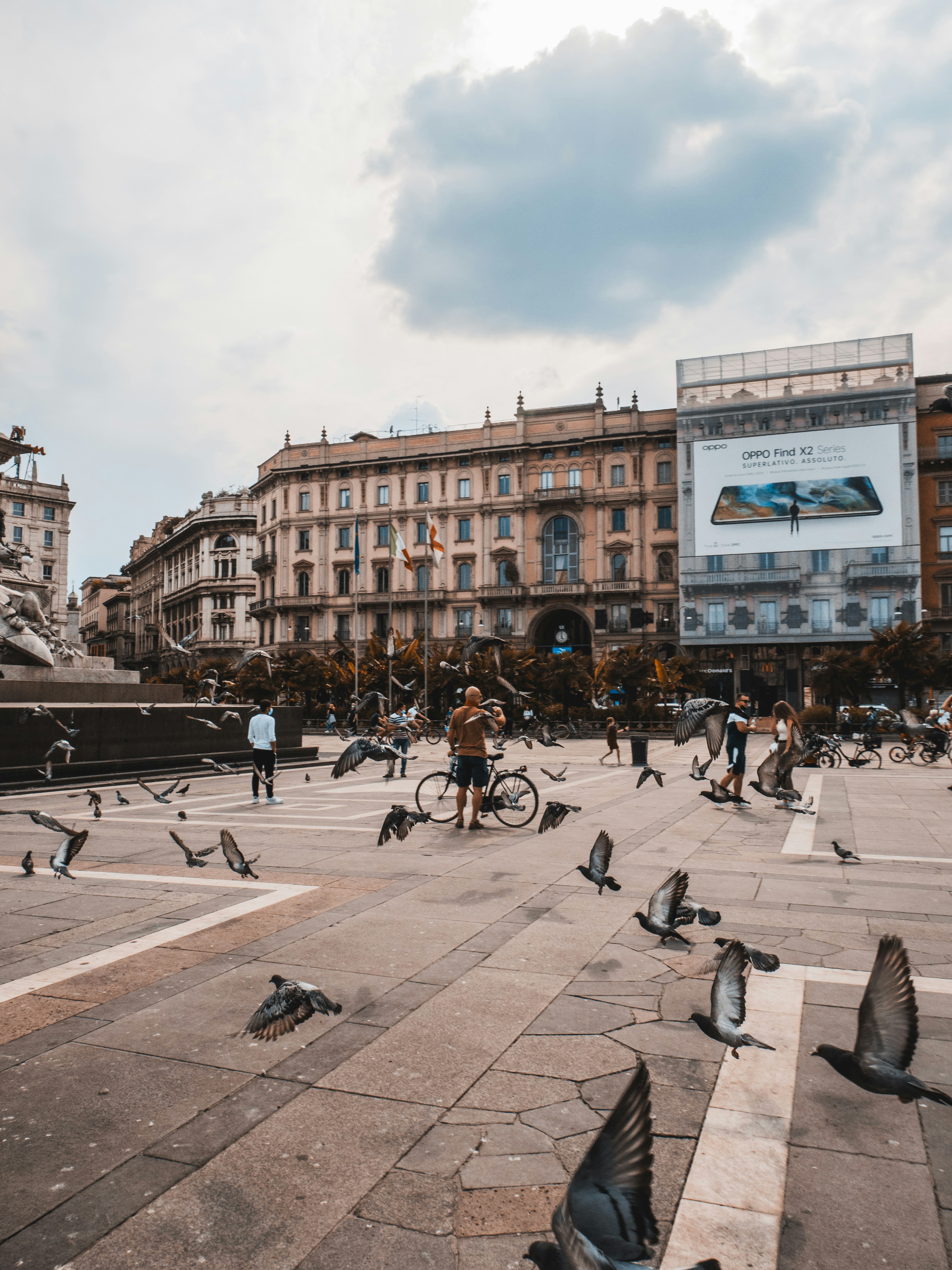 People walking on pedestrian lane near brown concrete building during ...