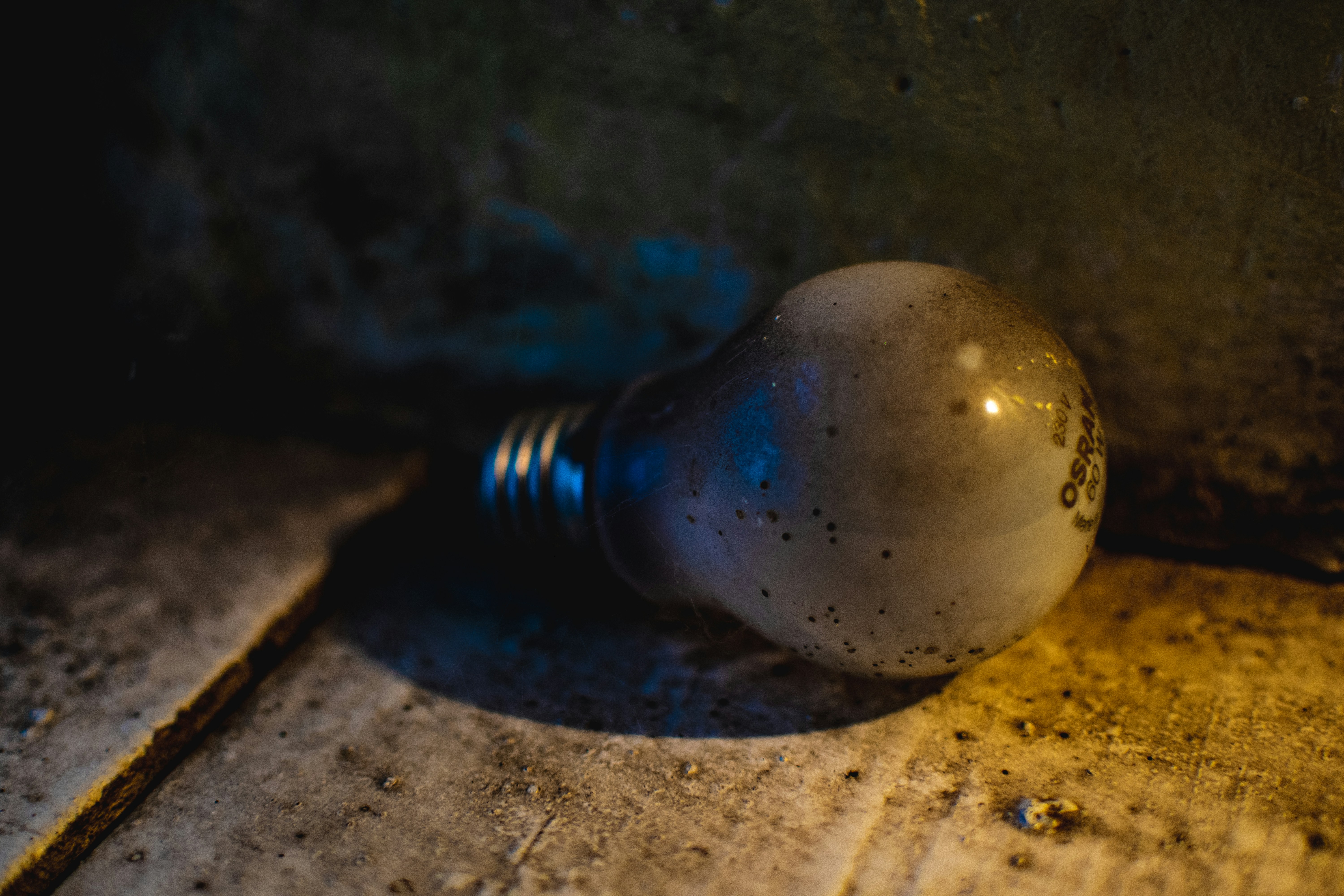 Dusty Edison Bulb Seated on a Weathered Concrete Stage