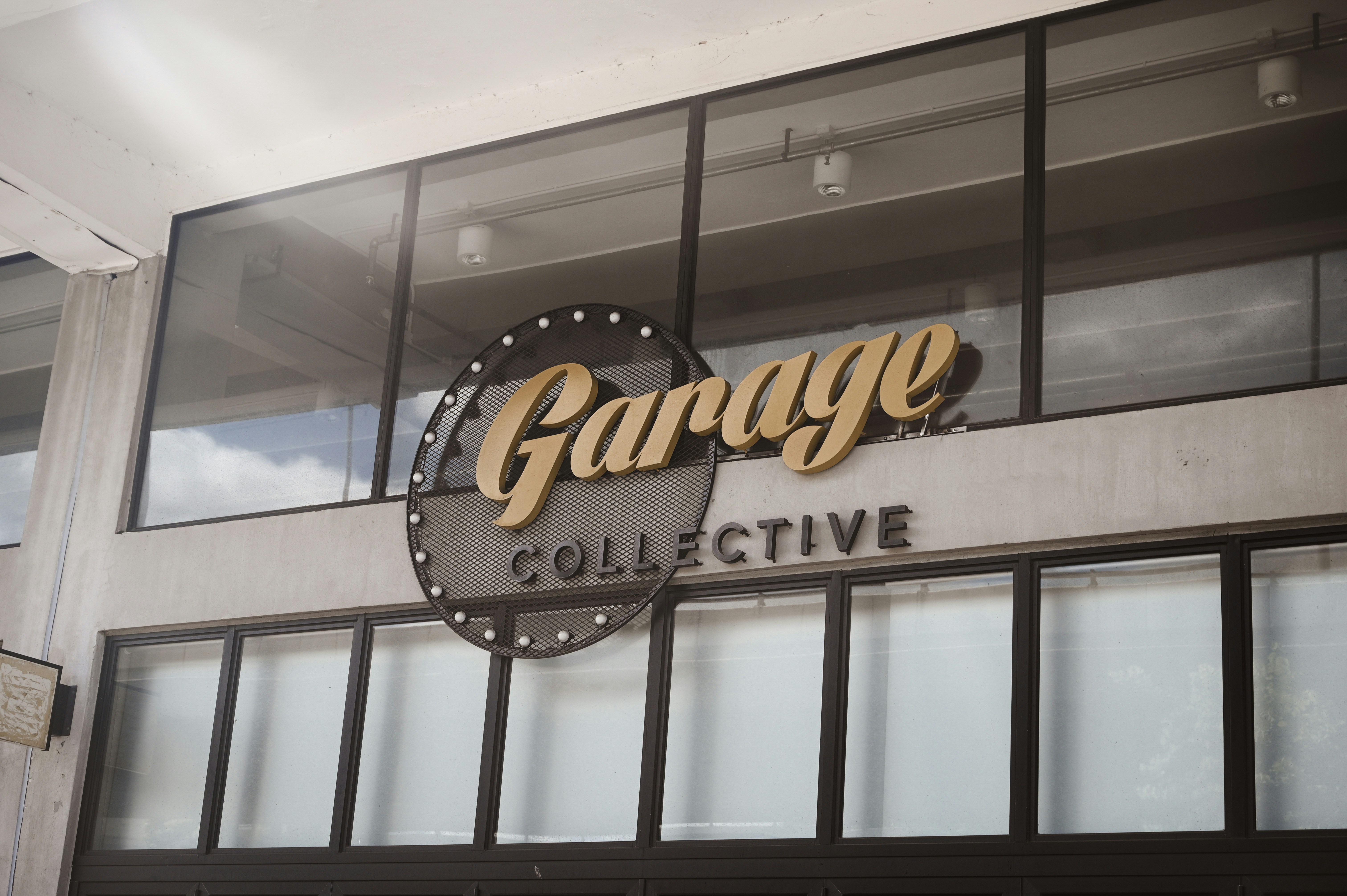 A garage collective sign on the side of a building photo – Free ...
