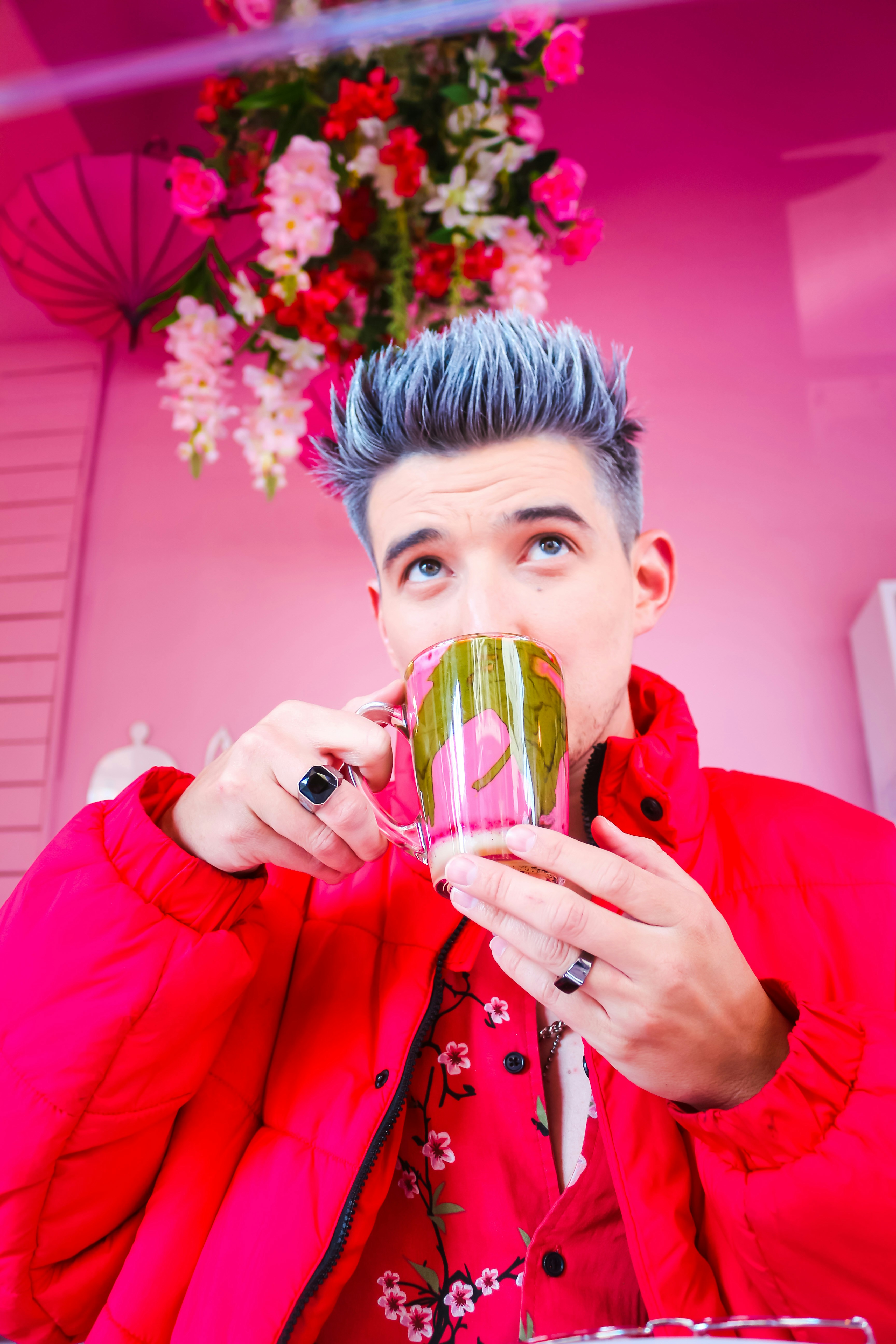 Azure Hair, Crimson Jacket, and a Pink Bloom Backdrop: A Quiet Portrait Sip