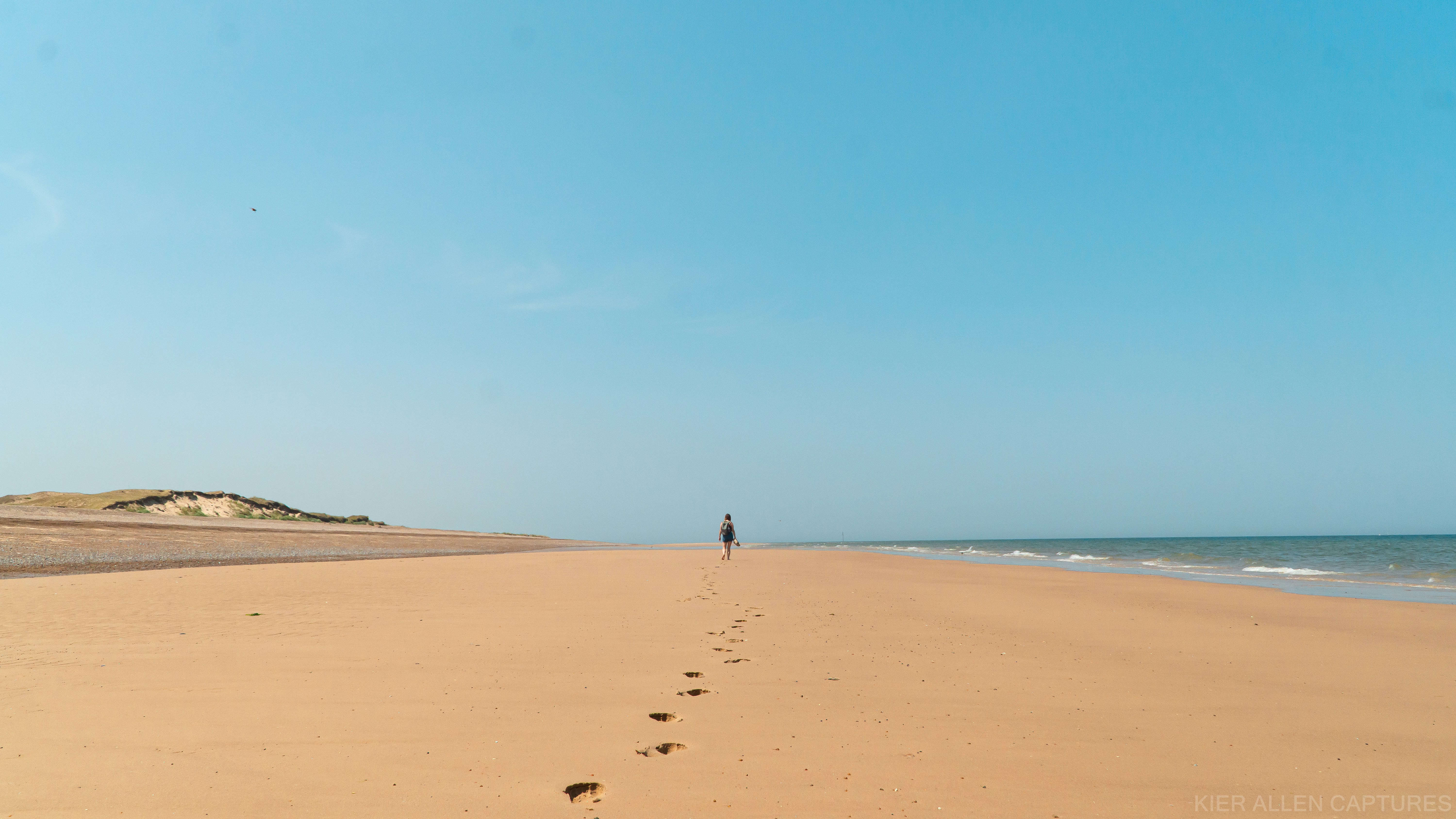Person walking on beach during daytime photo – Free Beach Image on Unsplash