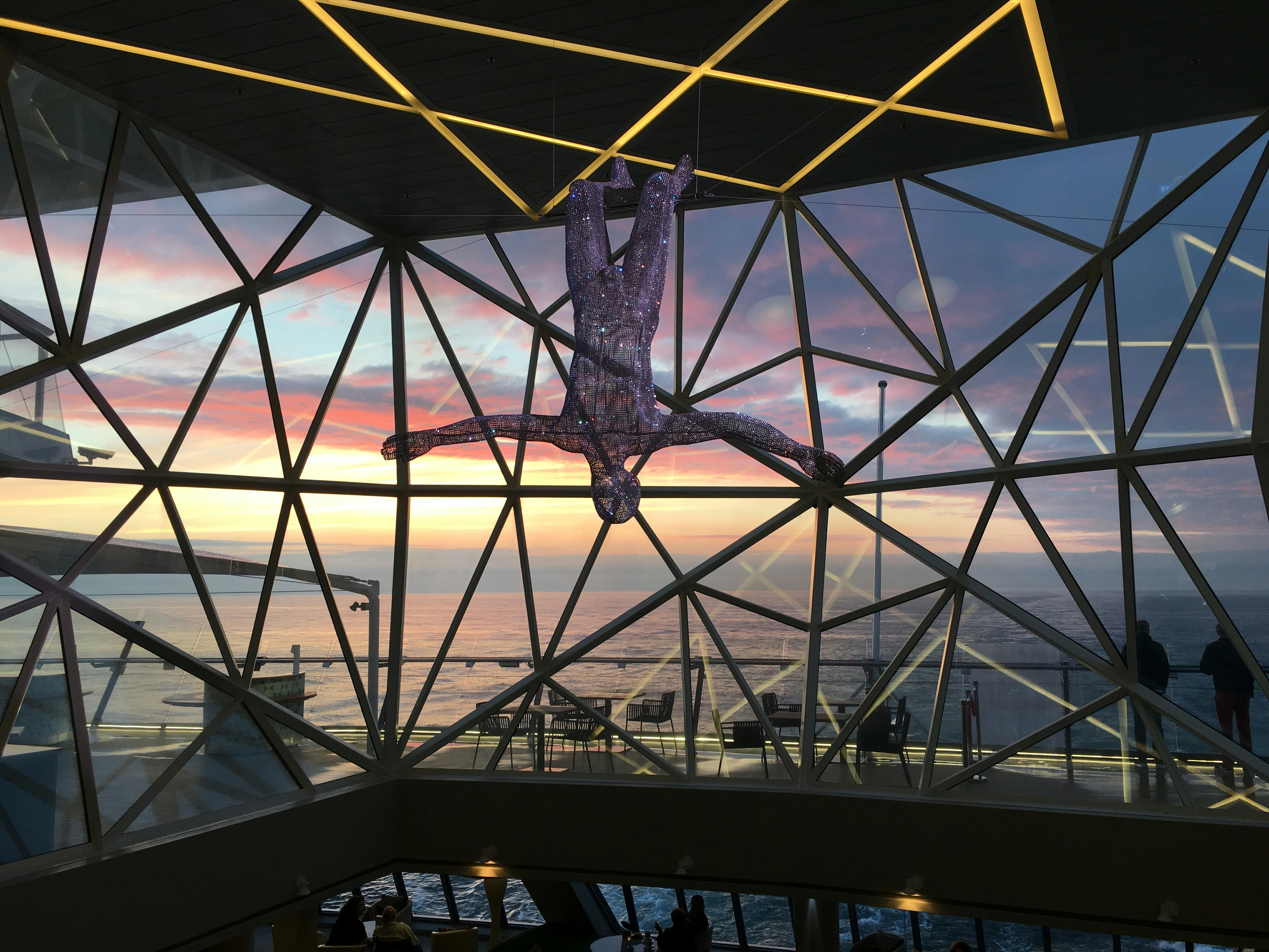 Upside-Down Acrobat in a Sunset Geodesic Atrium