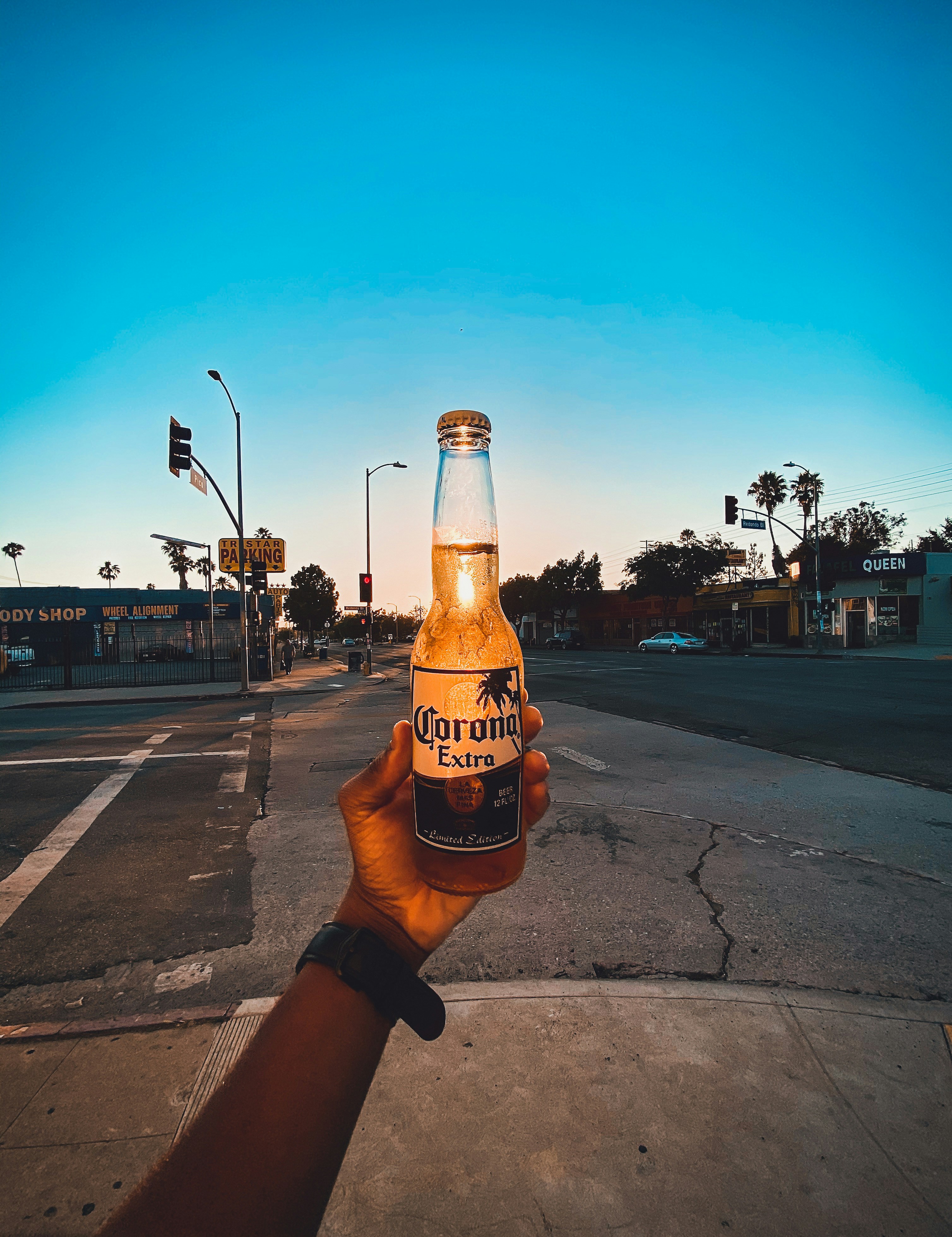 Palm-Short Sunset: Corona Bottle in an Urban Boulevard