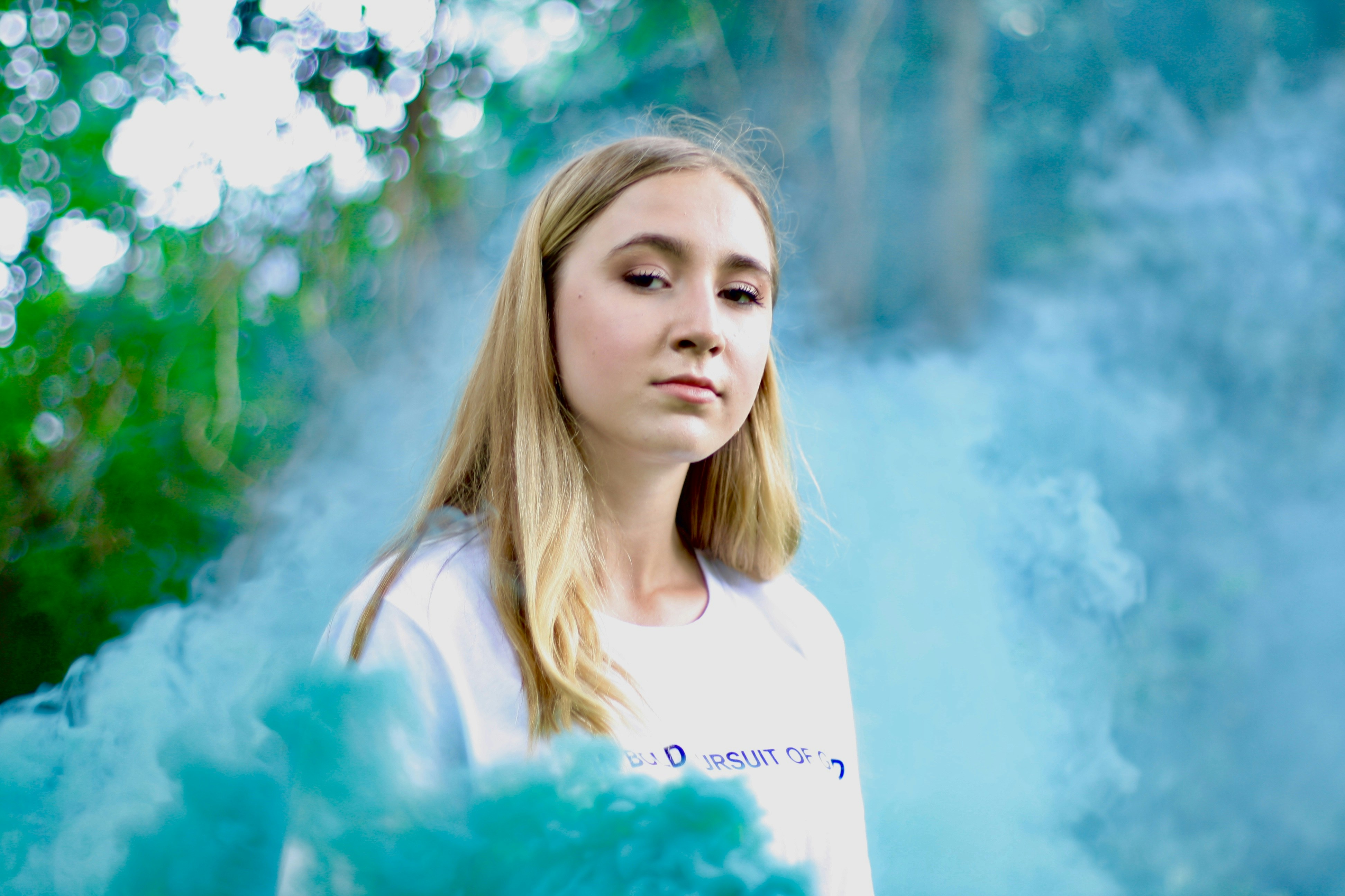 Gaze Through Cyan Smoke: A Forest Portrait in Soft Afternoon Light