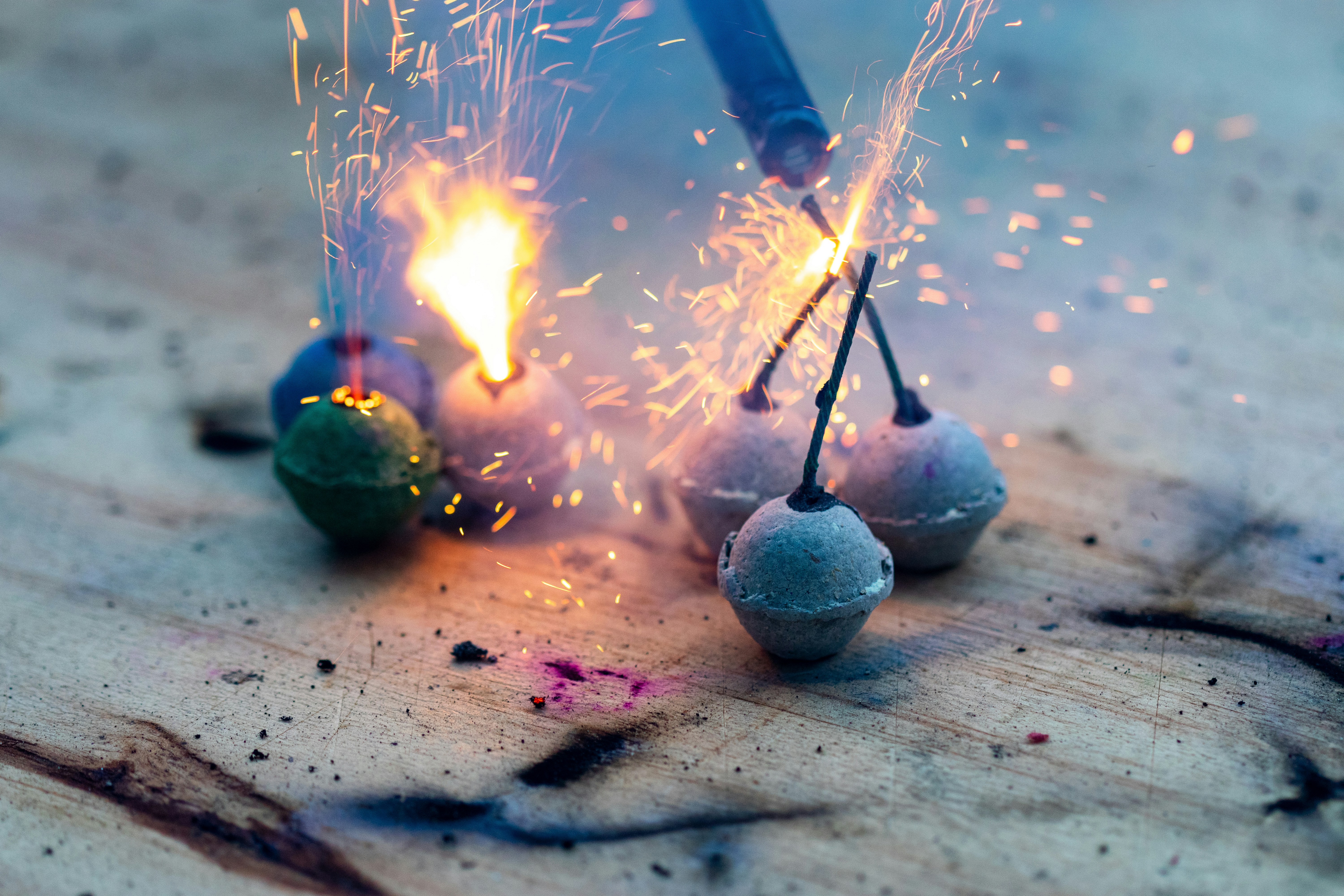 Pastel Cake Pops Meet a Brief Spark: A Micro-Bonfire on Weathered Wood