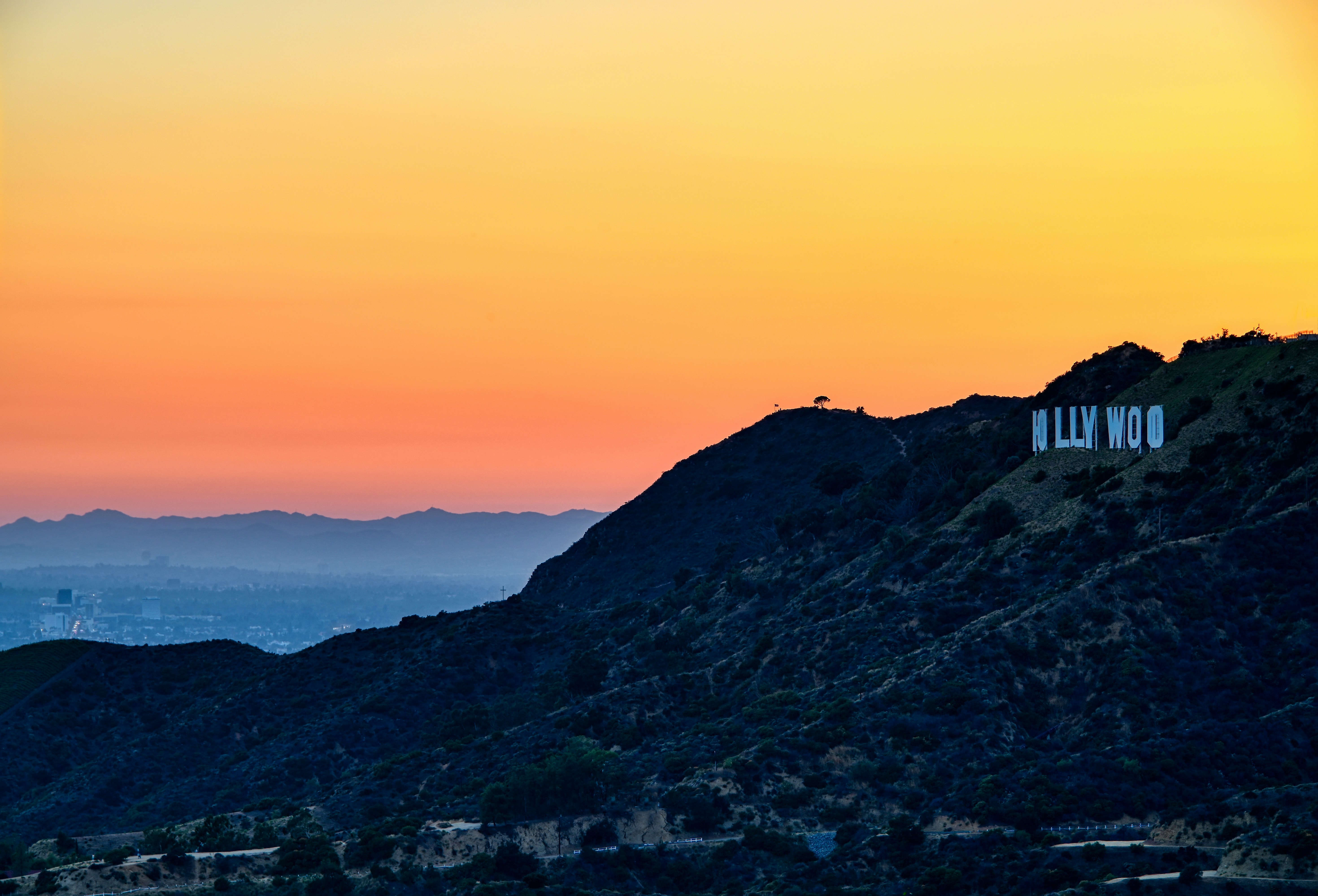 Sunset over the Hollywood sign  | white concrete building on top of mountain during daytime