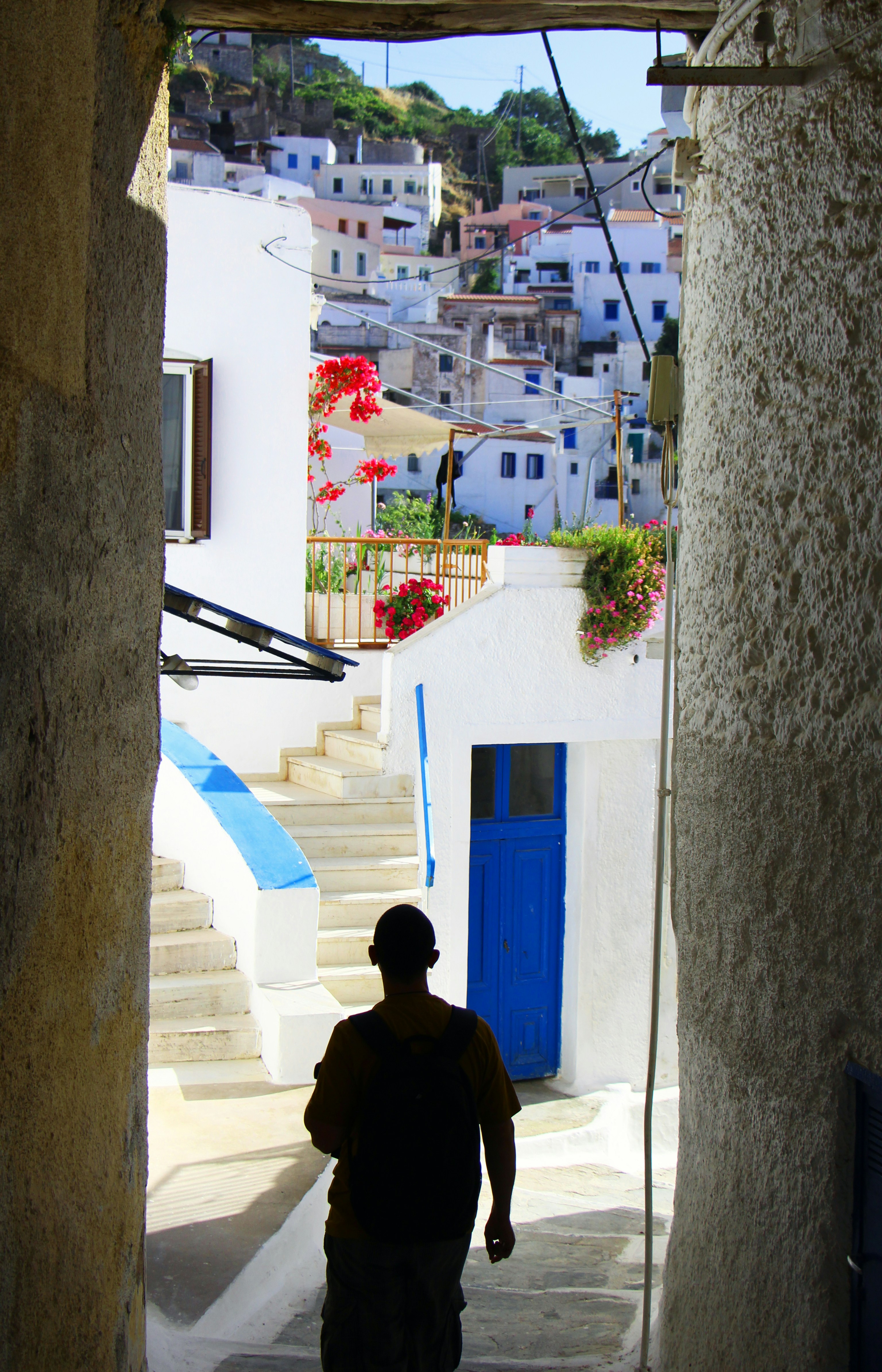 Silhouette at the Archway: A Quiet Return Through Whitewashed Steps