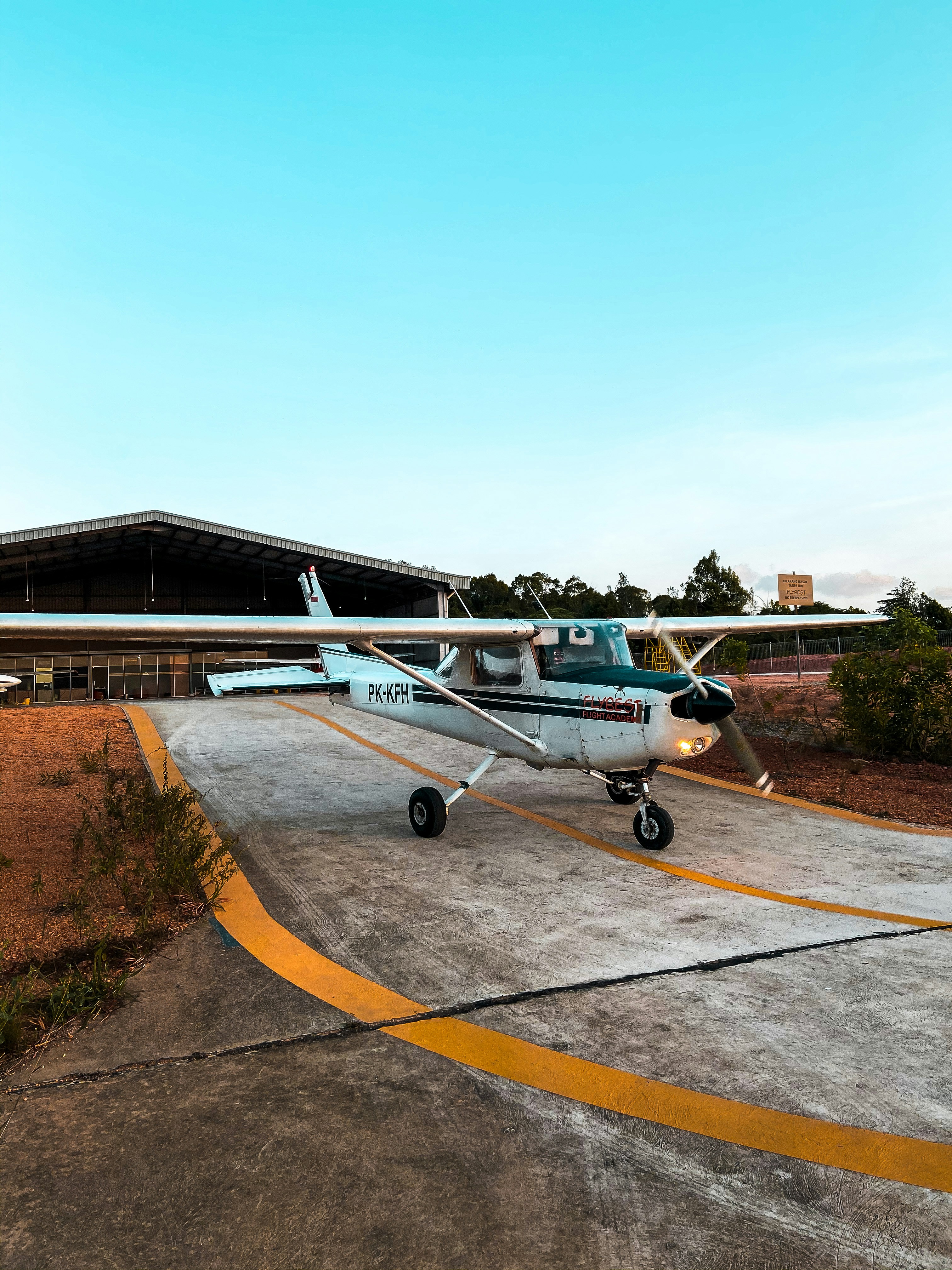 Cerulean Sky and Grounded Wings: A Small Prop Plane on a Sunlit Airstrip