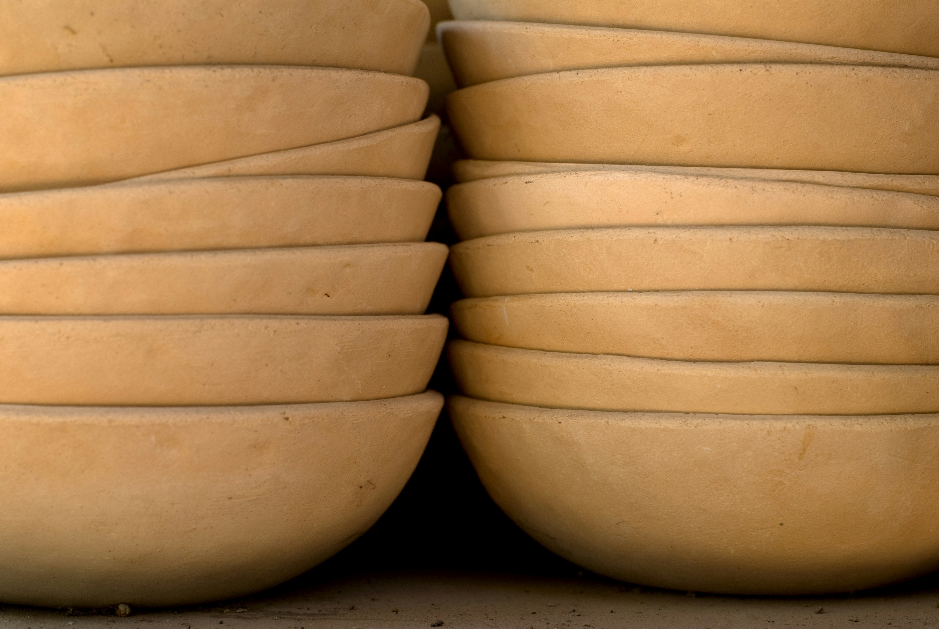 brown clay bowls on black surface