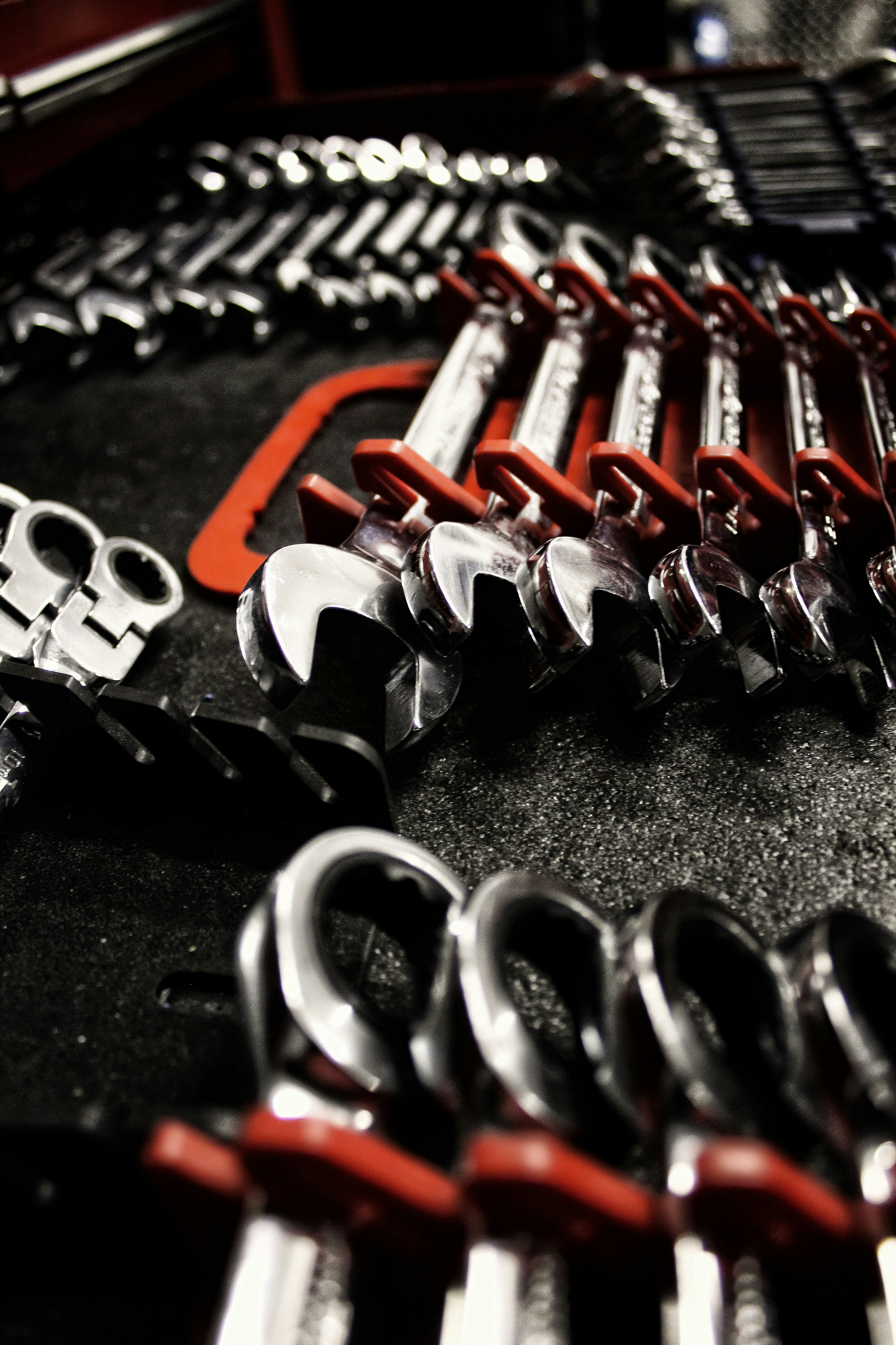 Red-Handled Wrenches Gleam on a Shadowed Workbench