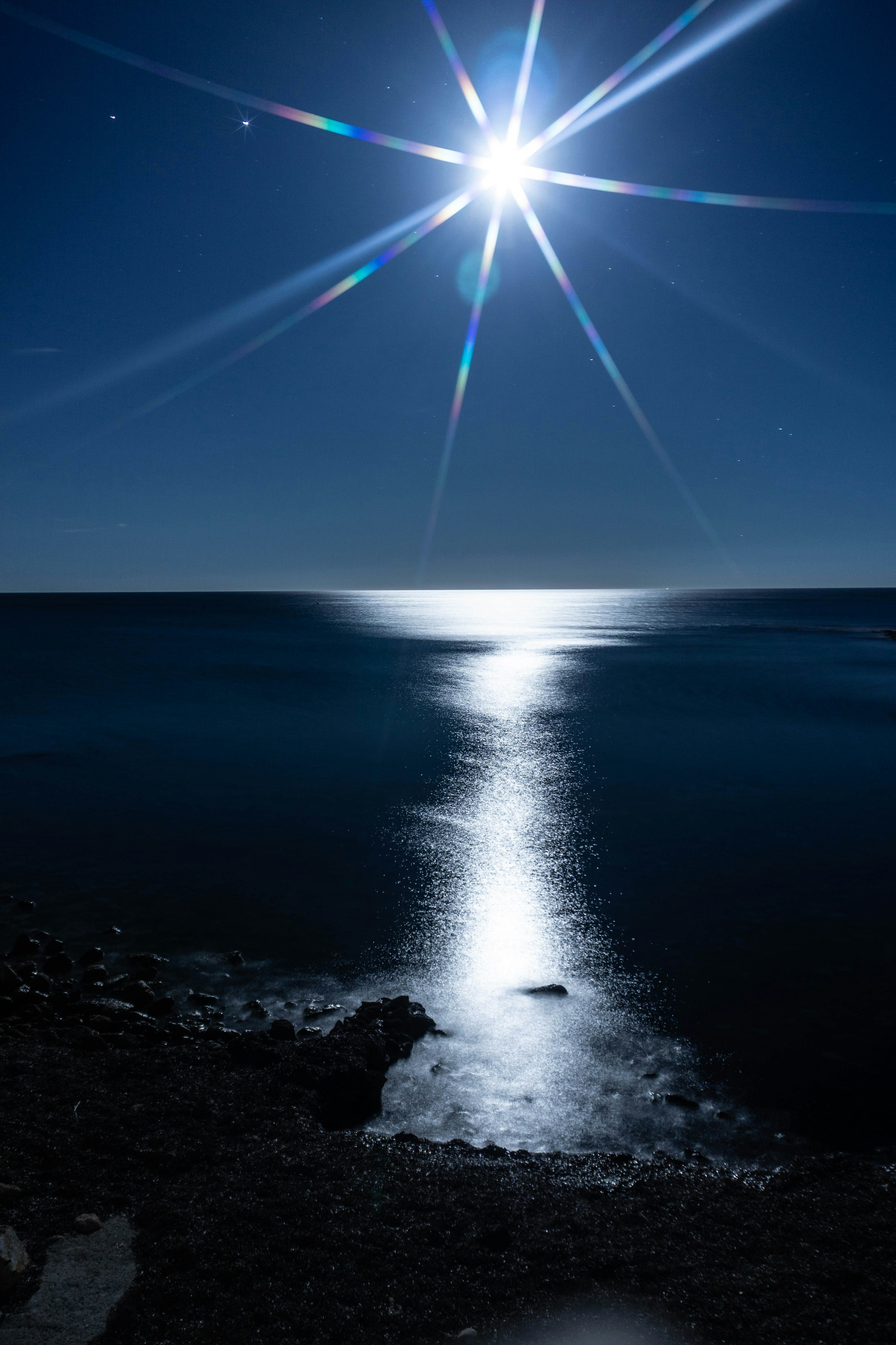 Full moon by the sea with long exposure | sun rays over the sea