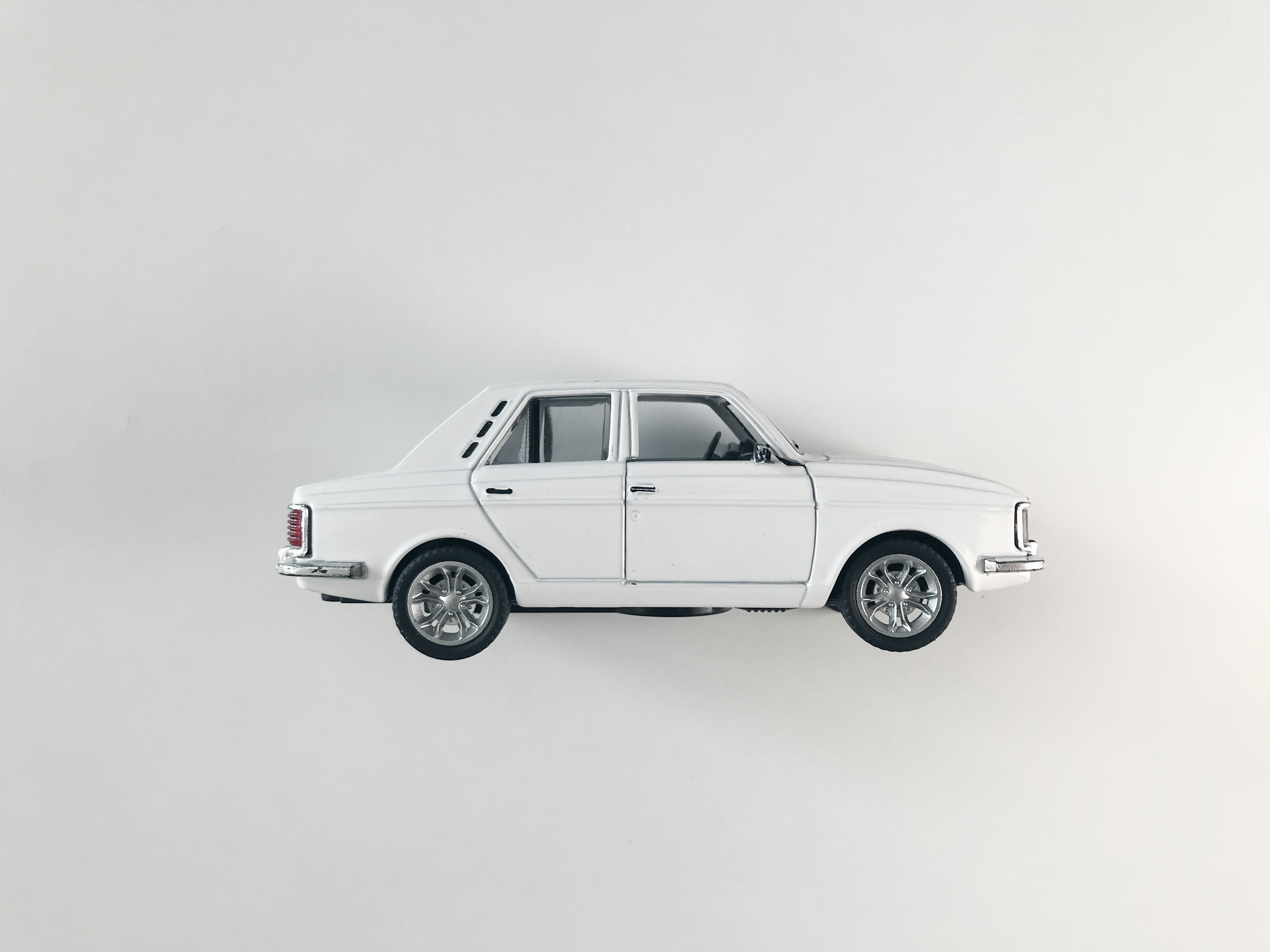 Minimalist White Classic: A Vintage Sedan in Studio Silence