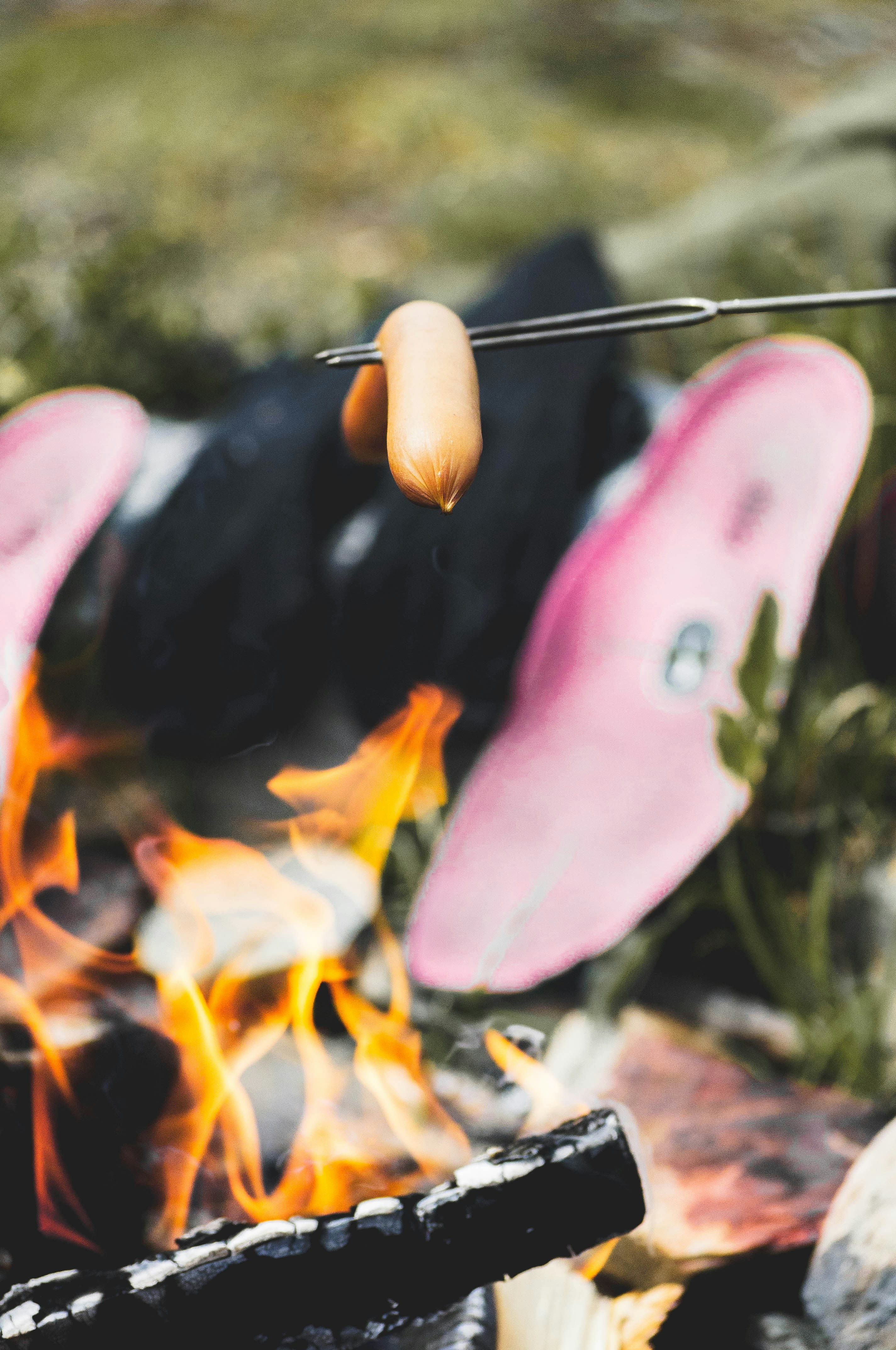 Ember-Skewered Snack Under Firelight with Blurred Pink Sneakers