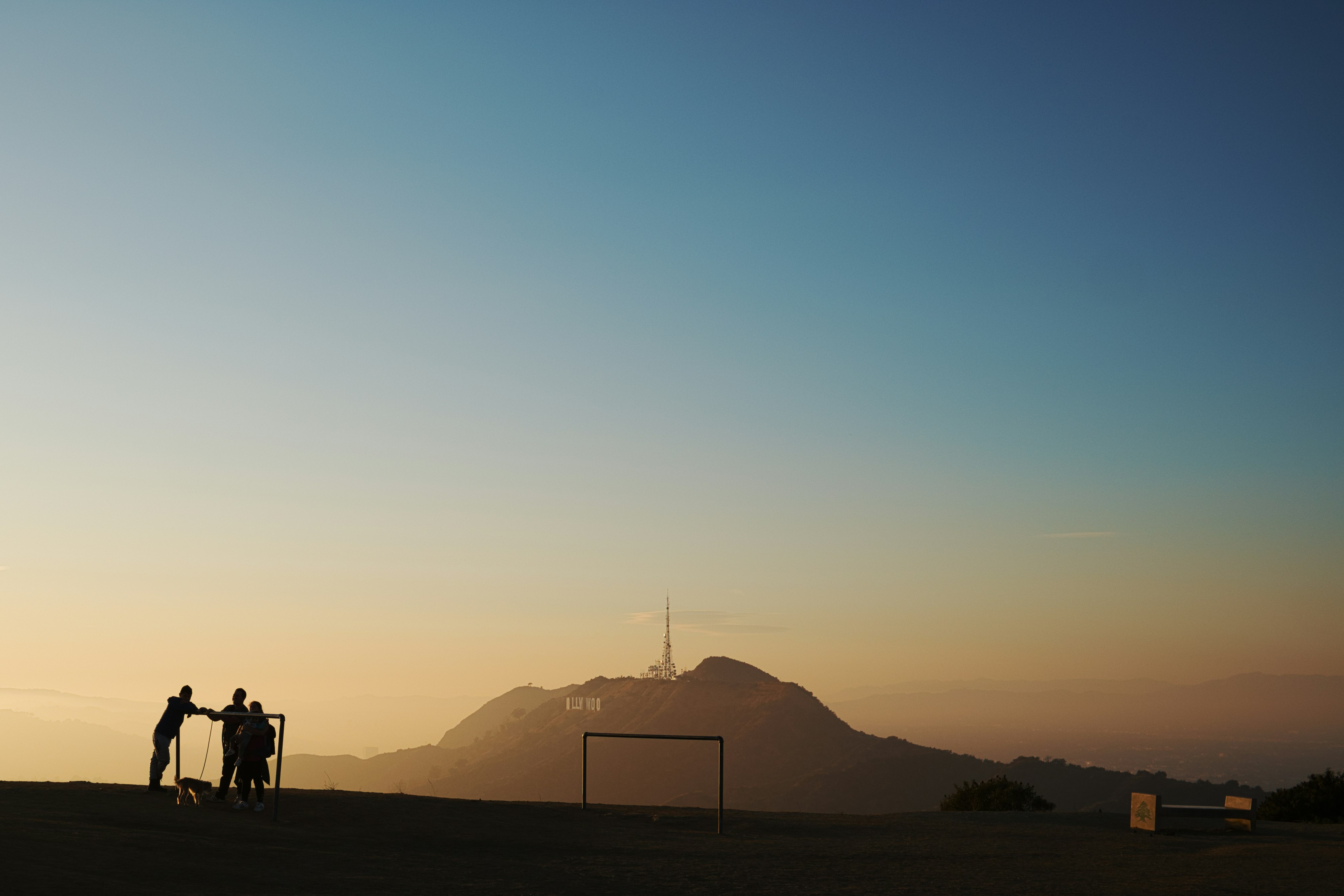 silhouette of 2 people standing on the ground during sunsetIvan Karpov