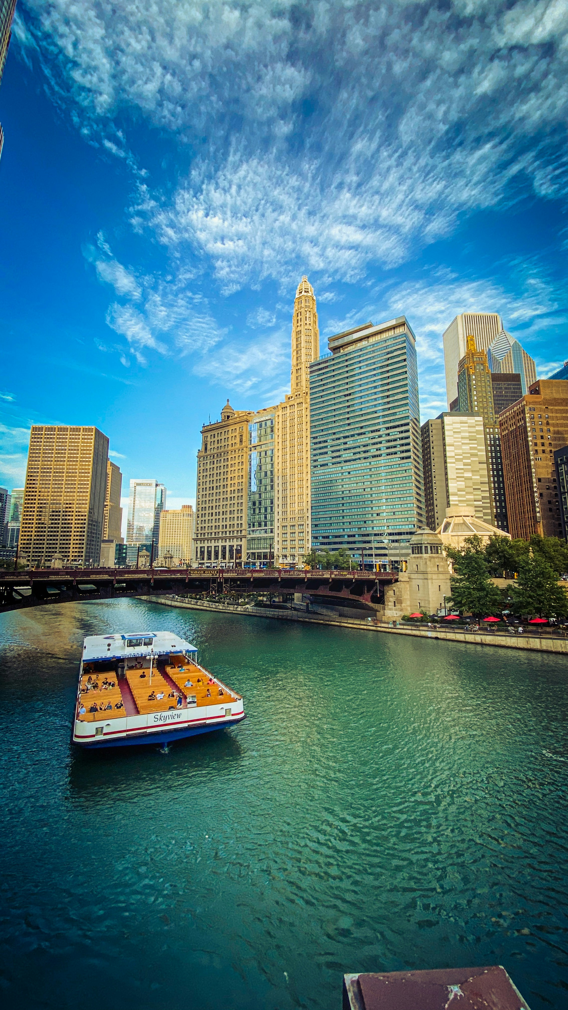 High rise buildings near body of water under blue sky during daytime ...