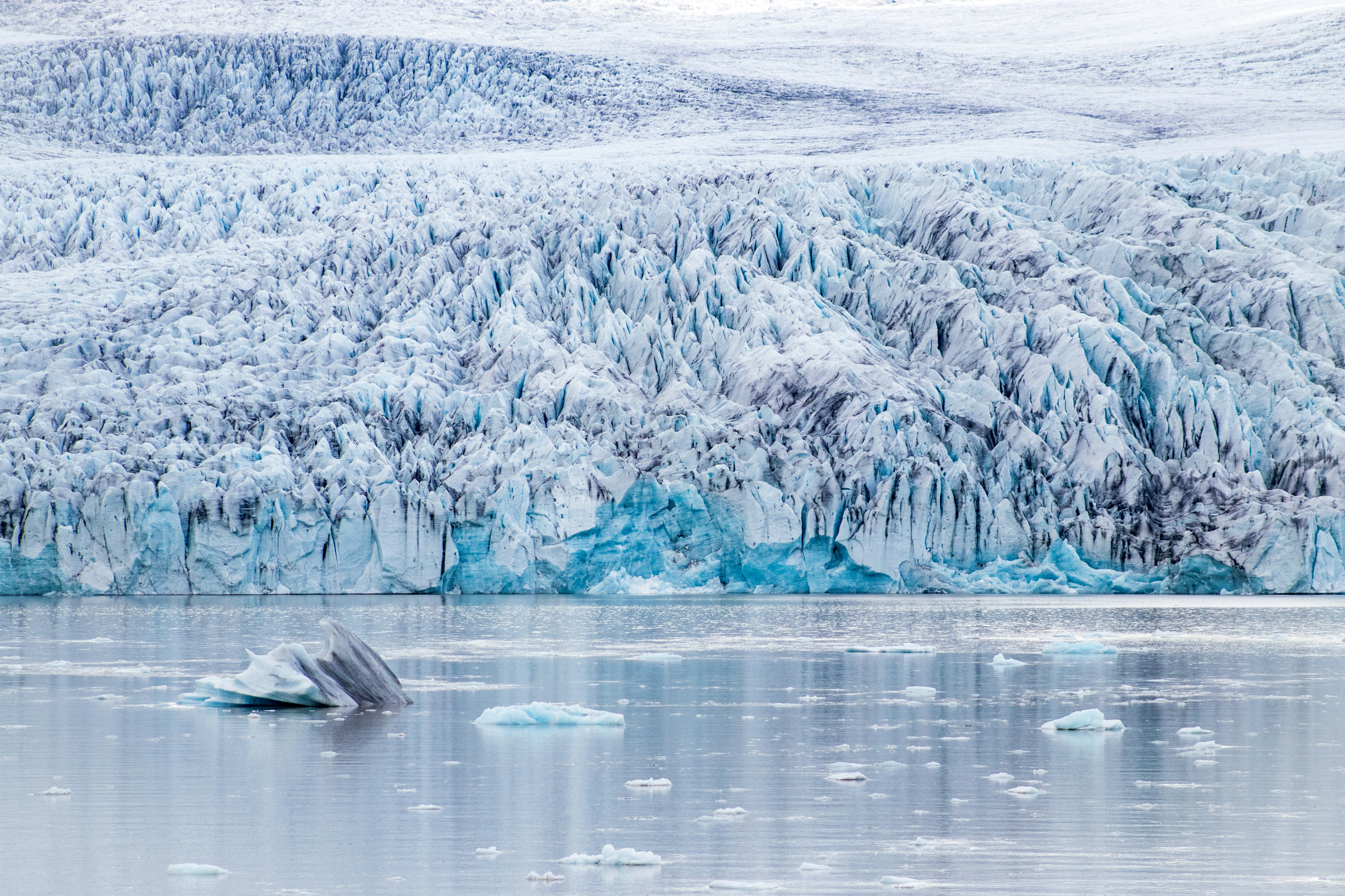 Drifting Ice Fragment Before a Cerulean Glacier Edge