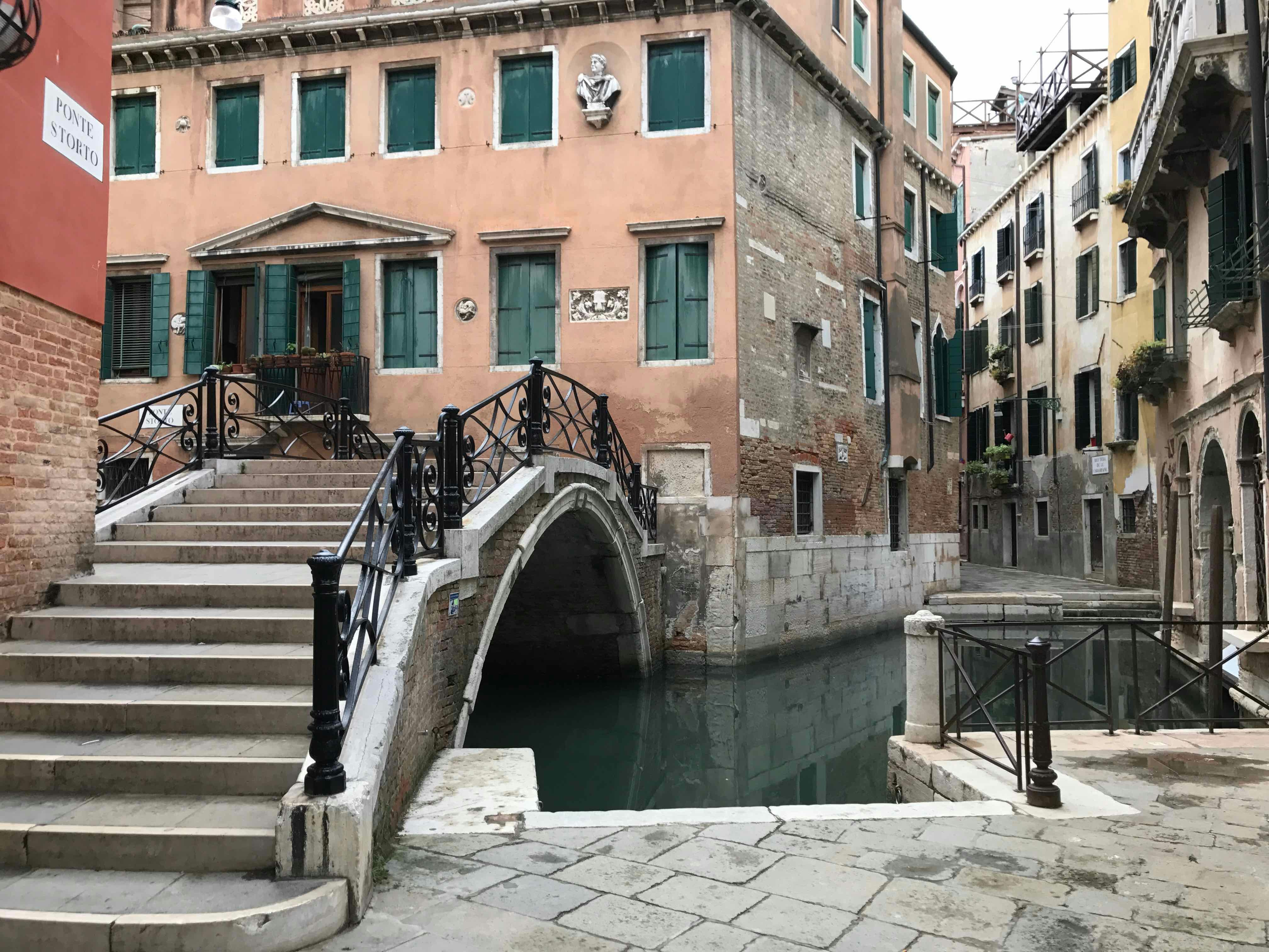 Stone Arch Over a Venetian-Style Canal: Weathered Facades in Quiet Light