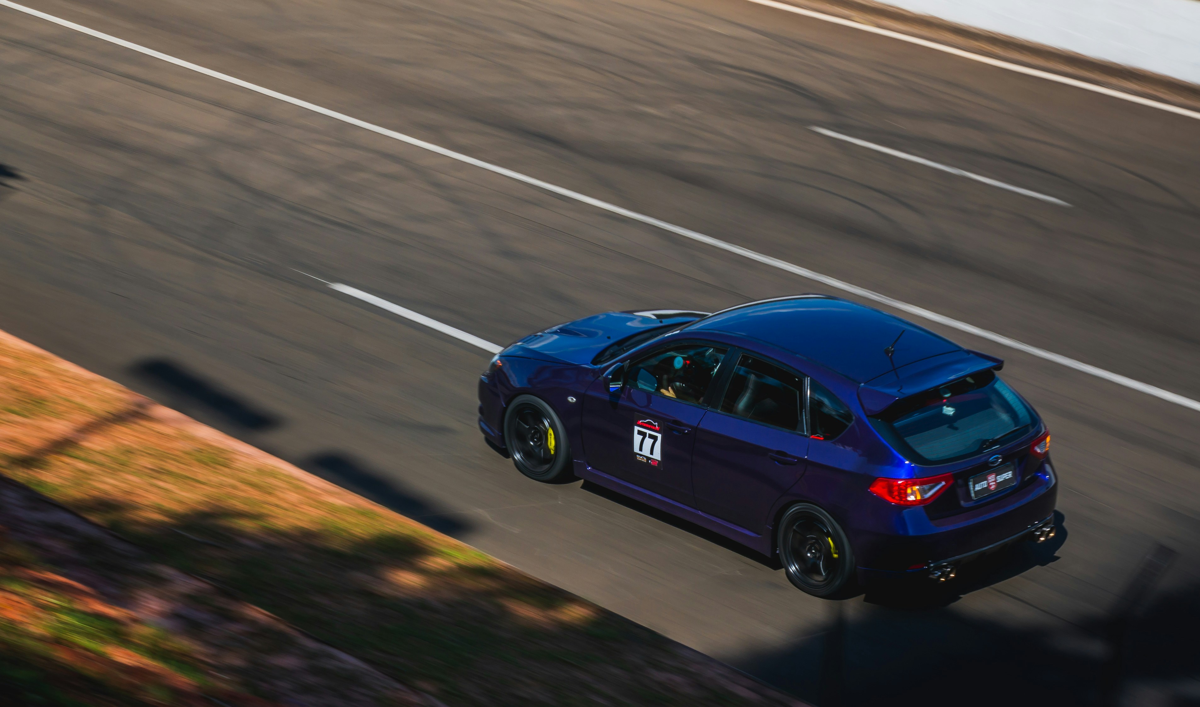 Blue Siren on the Asphalt: A Racing Snapshot in Flight