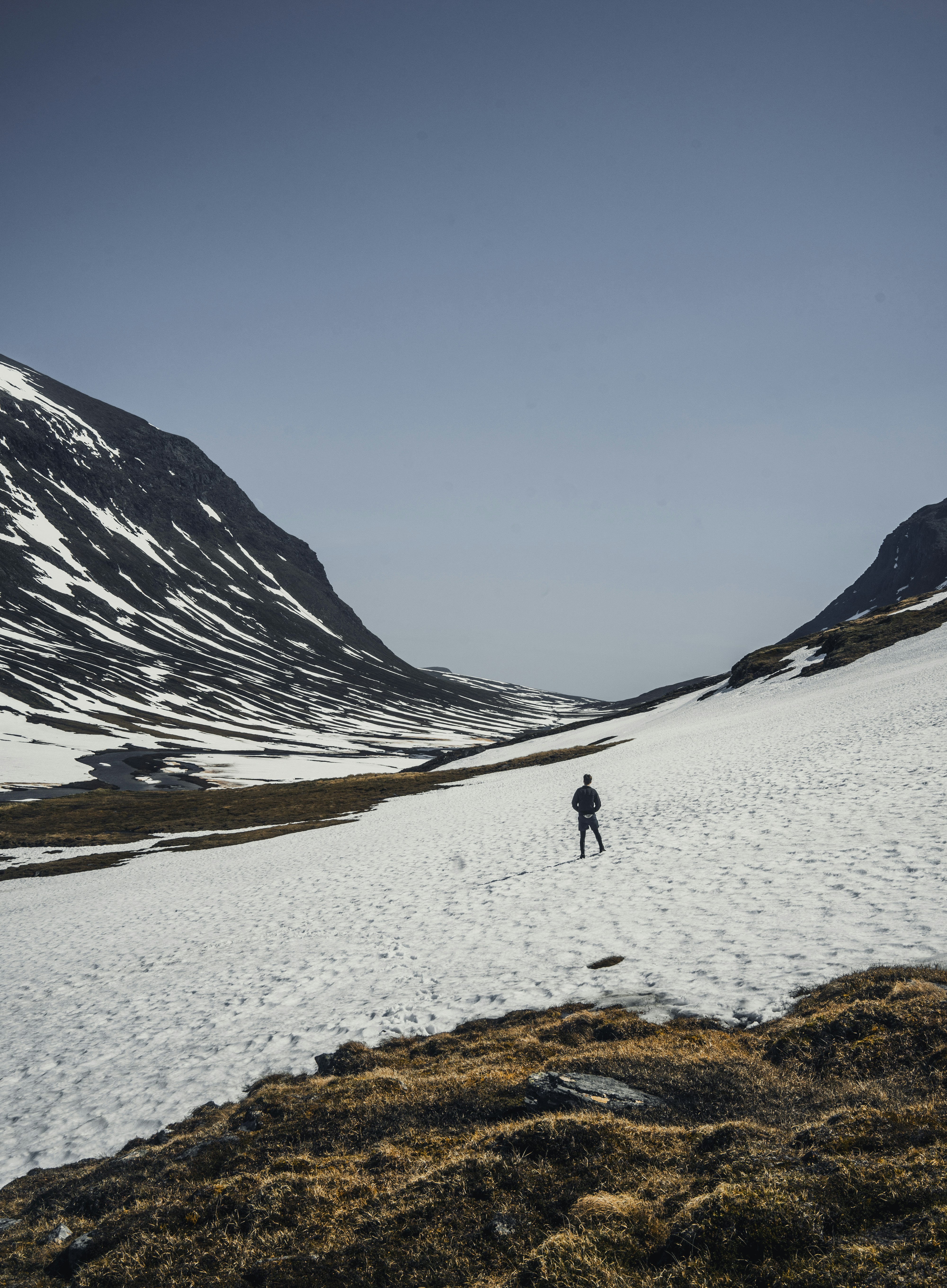 Person walking on snow covered field during daytime photo – Free ...