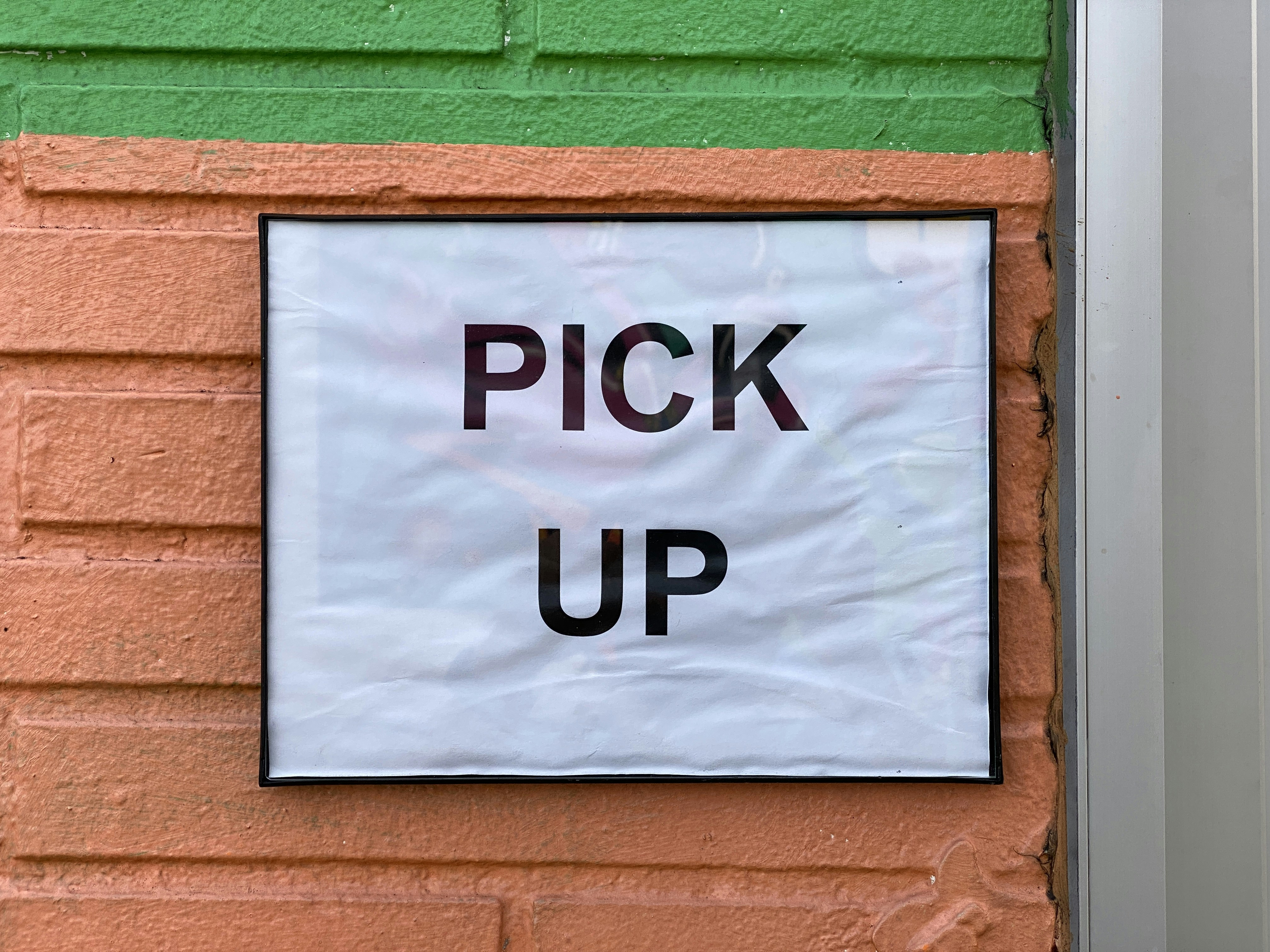 A sign on the side of a building that says pick up photo – Free Text ...
