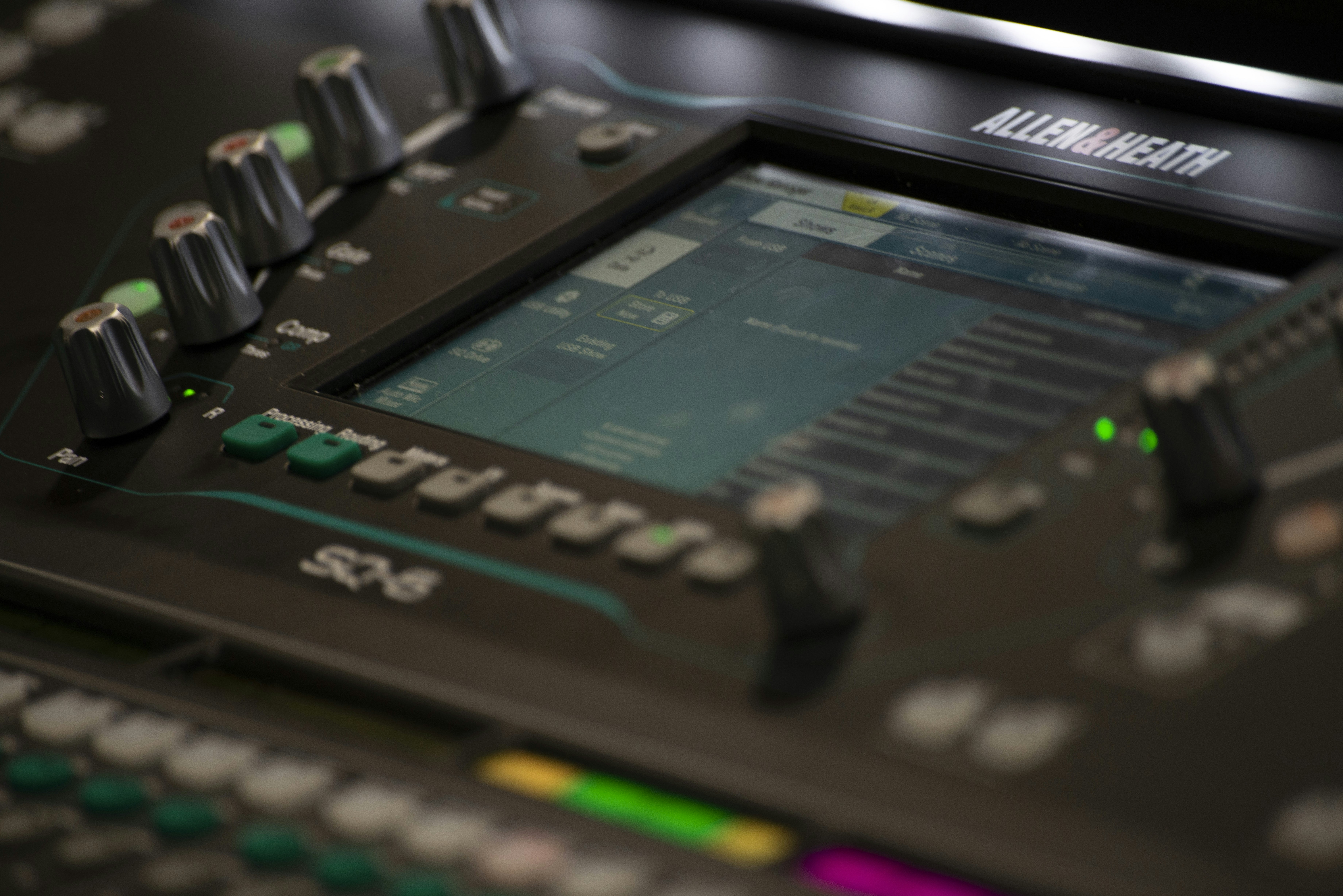 Digital mixing console interface with tactile controls and a vibrant touchscreen display, showcasing audio settings and adjustments.