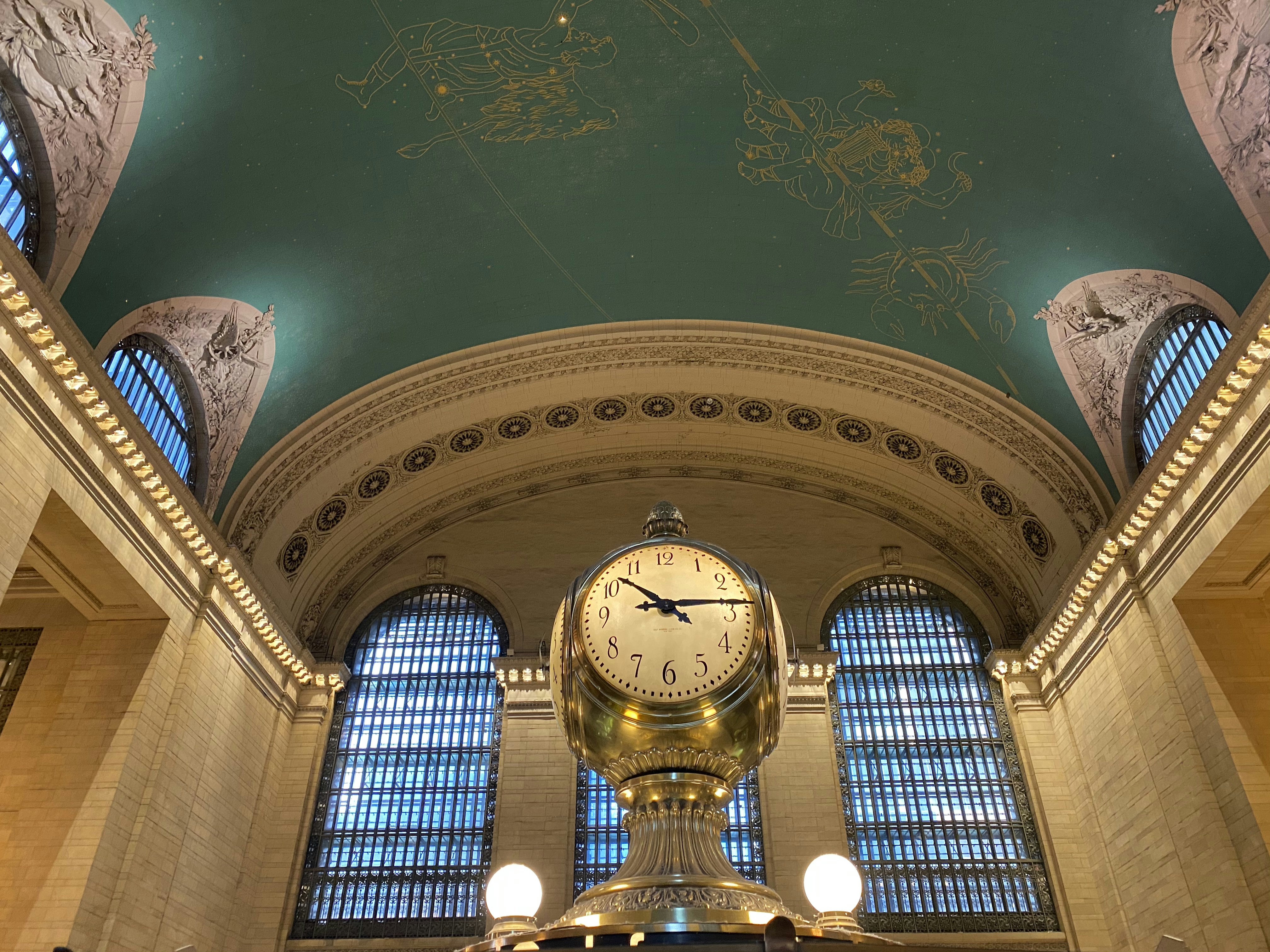 gold and white analog clock