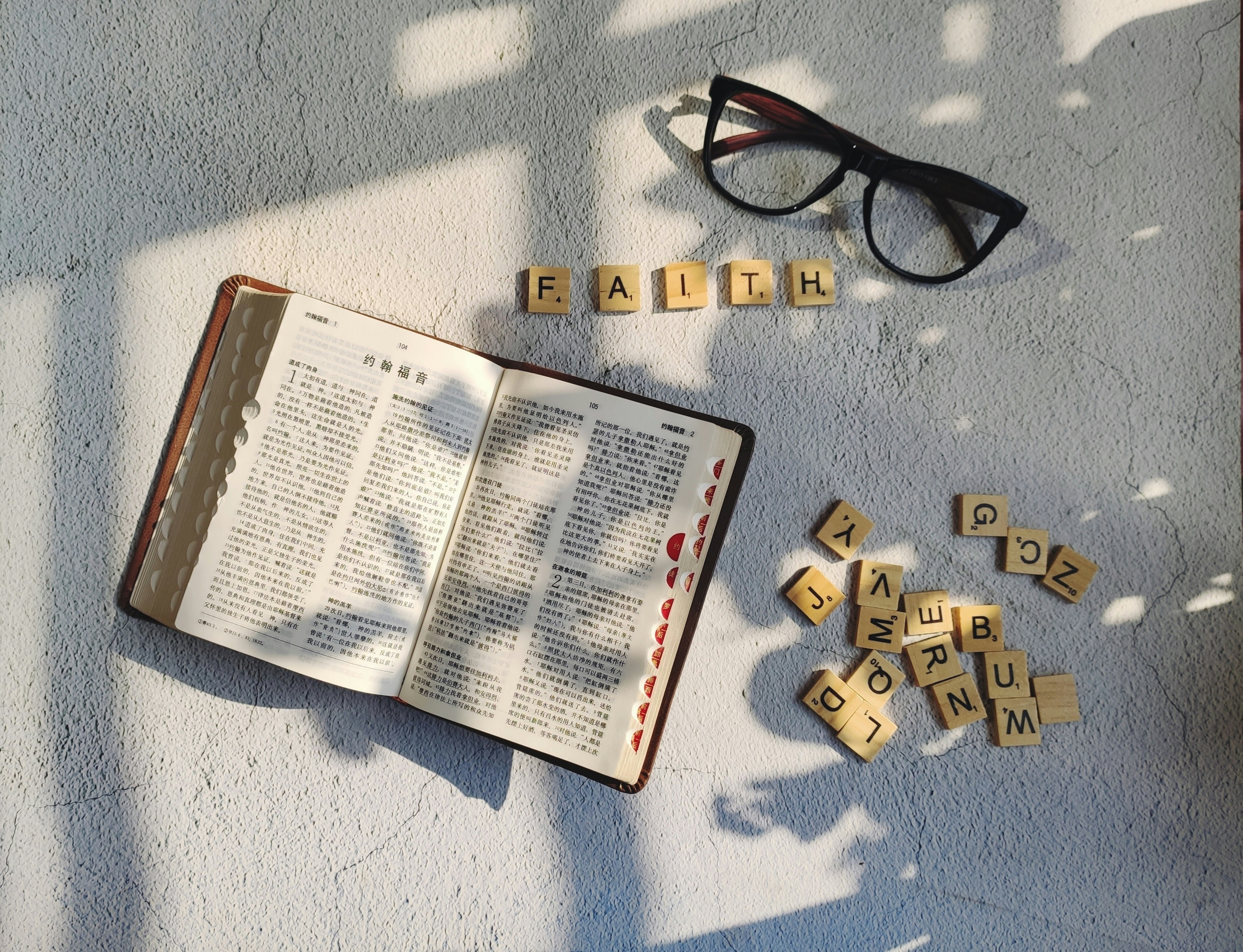 Faith in Focus: An Open Bible Under Soft Shadowed Light
