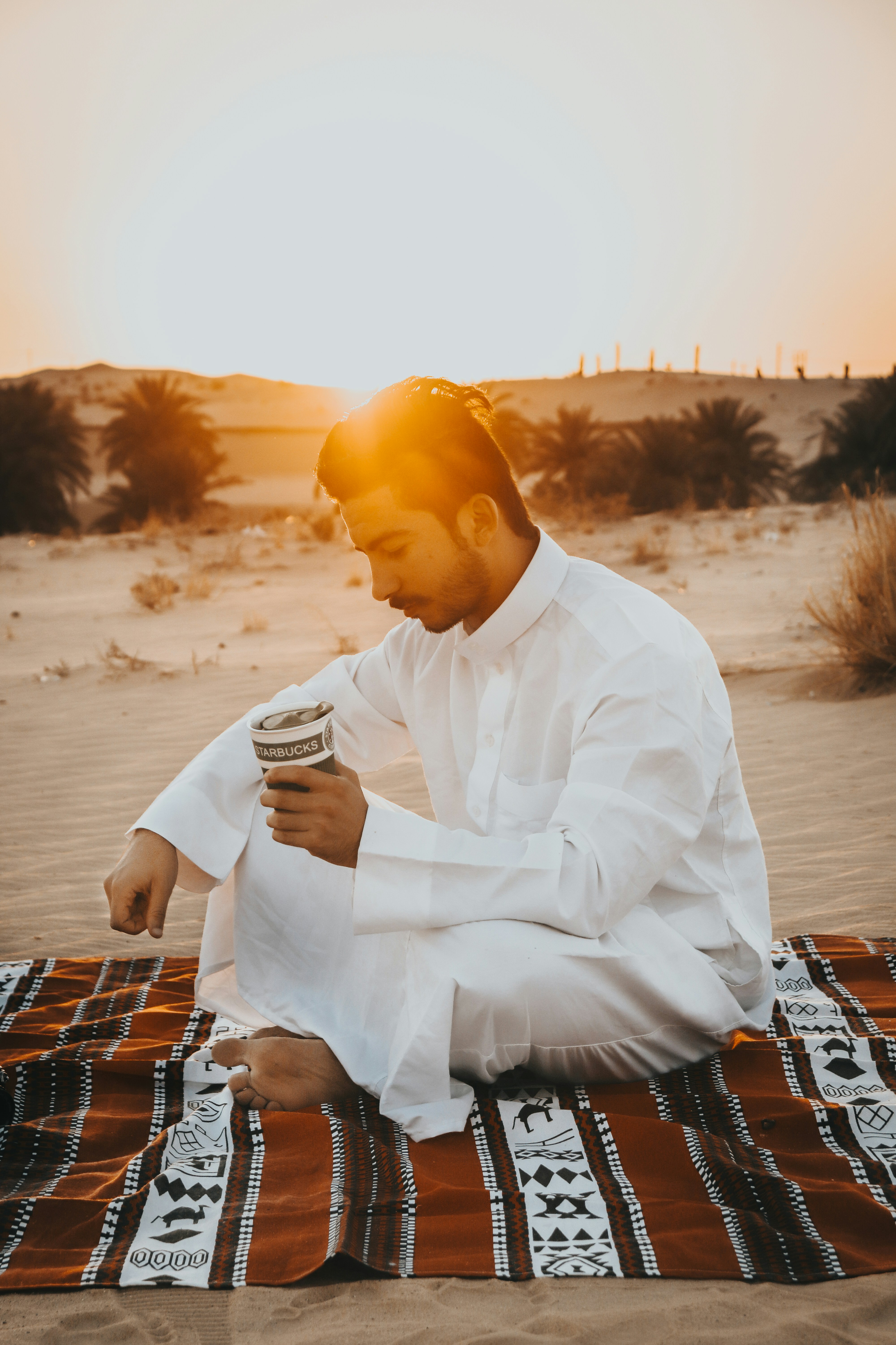 Dunes at Dusk: A White-Garbed Pause with Starbucks