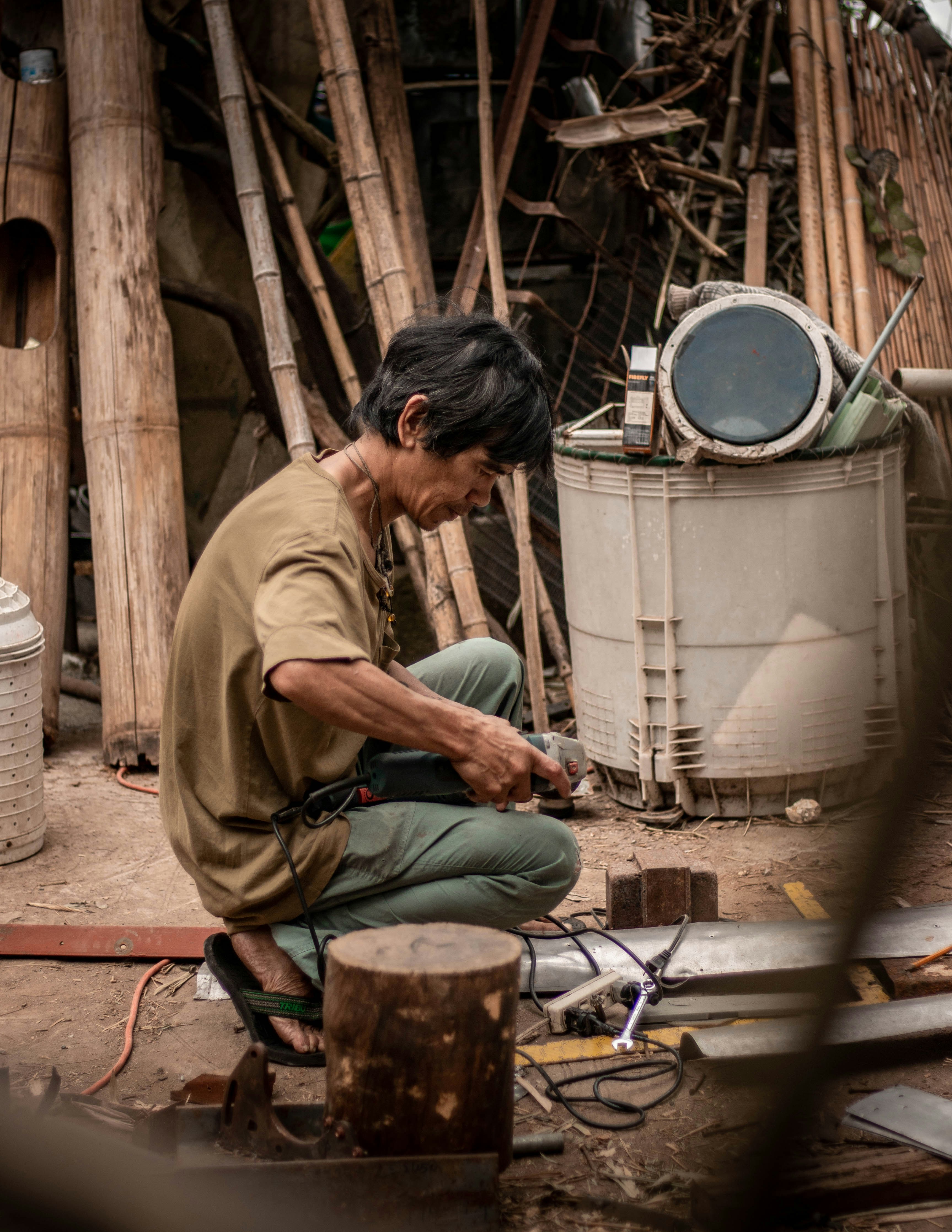 A Craftsman's Hands: Quiet Focus in a Cluttered Yard Workshop