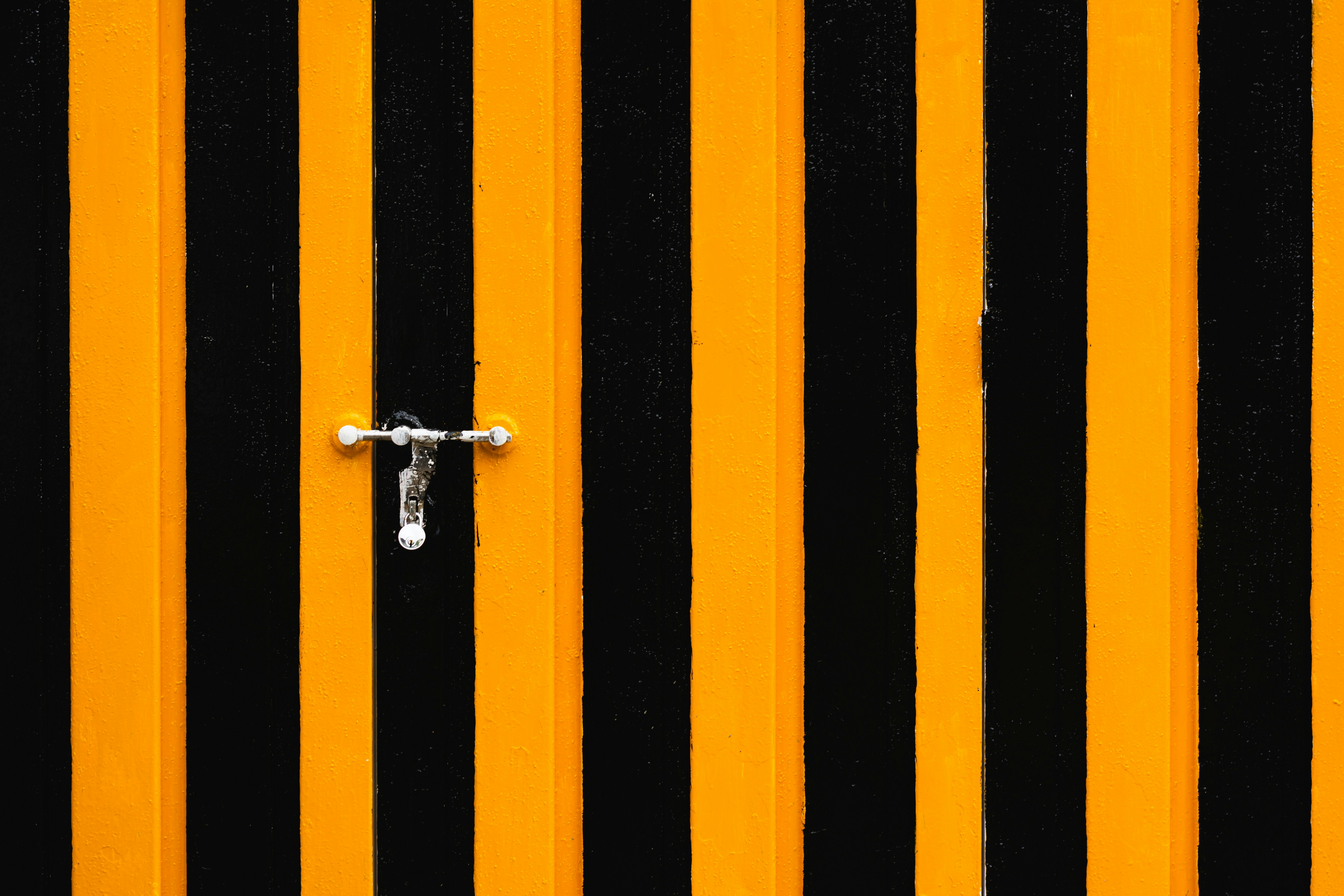 Chrome Latch on a Striped Facade