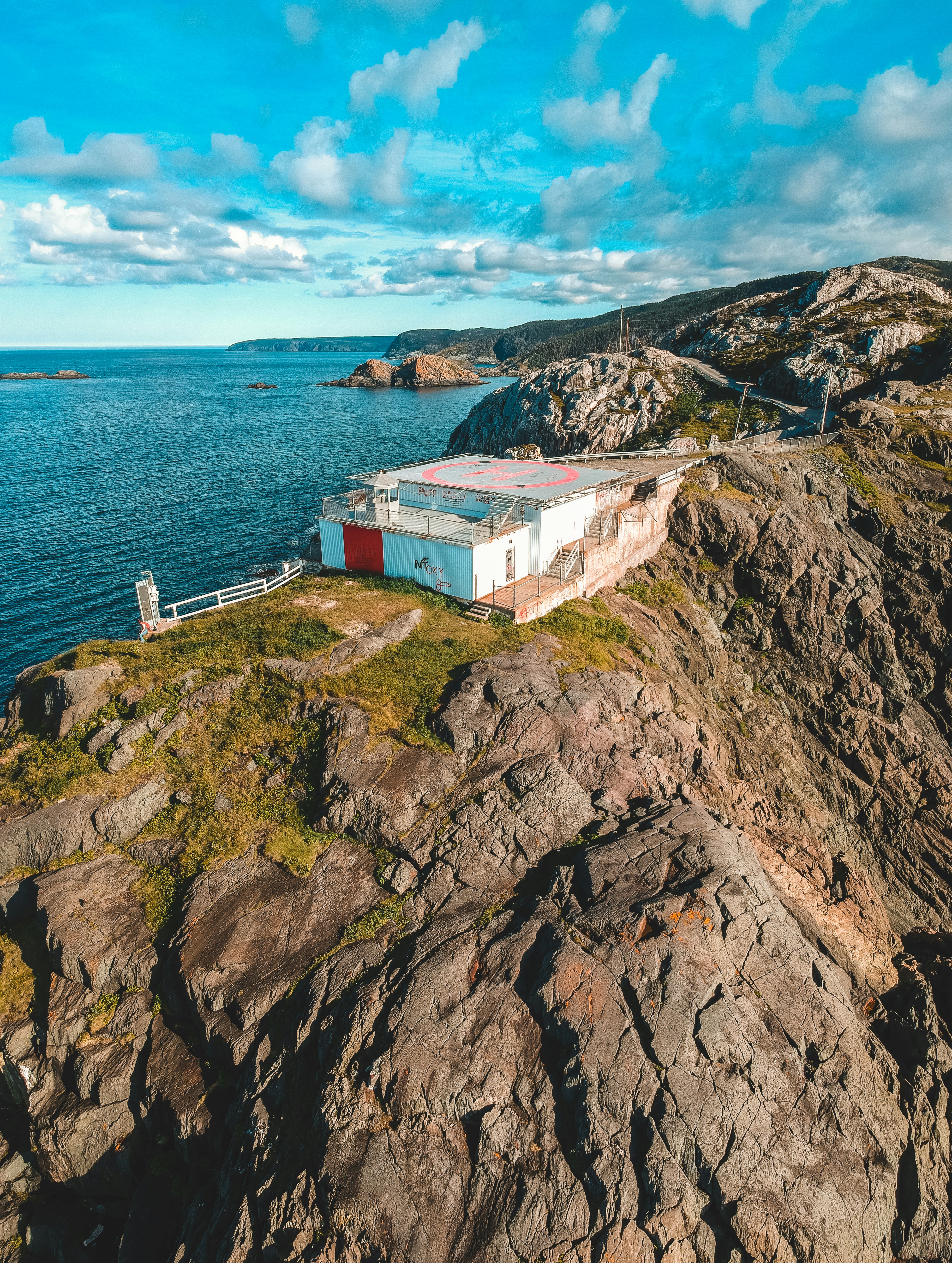 Clifftop Coastguard: A White Shelter Amidst Rugged Granite Overlooking the Sea