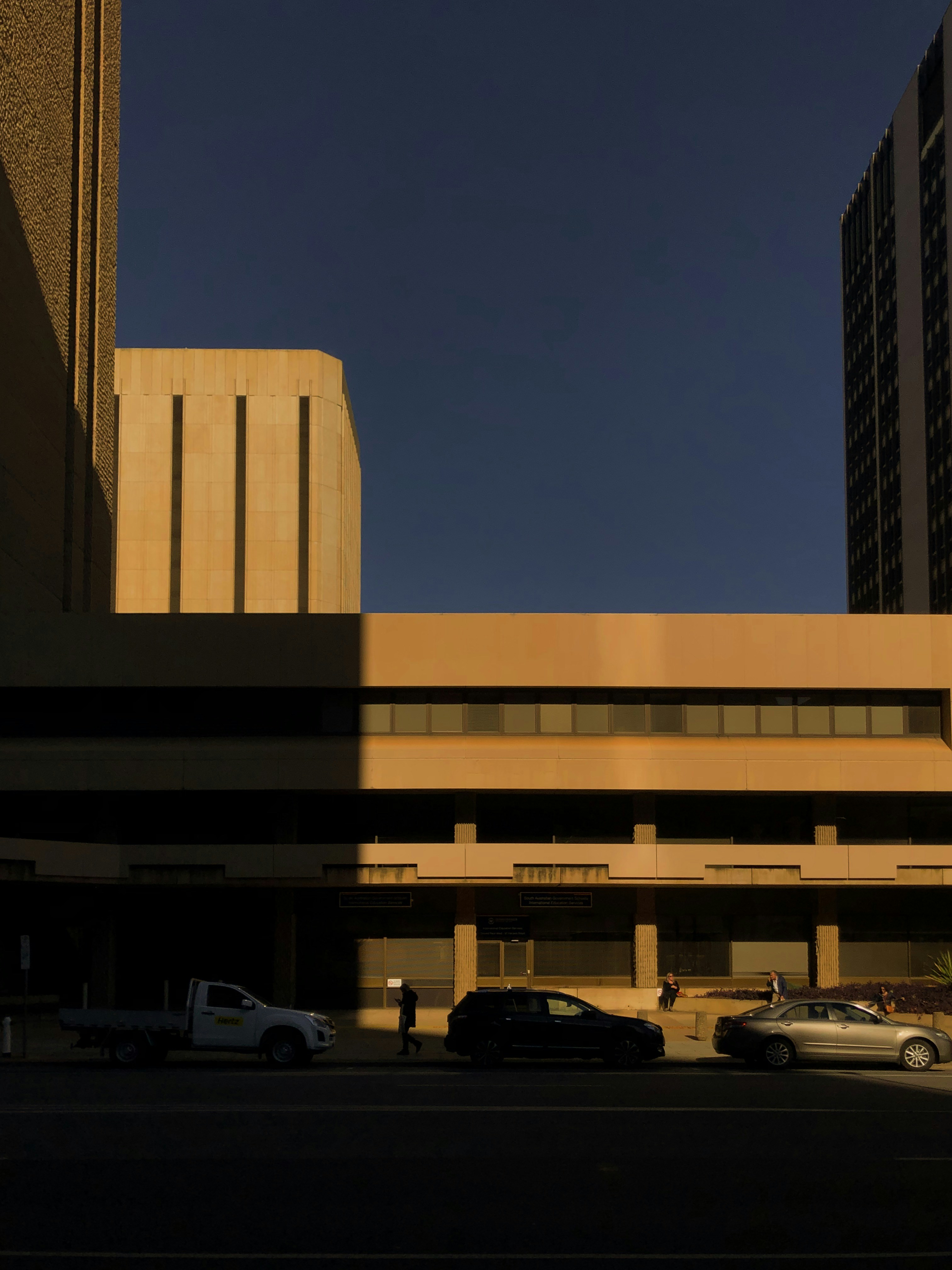 Golden Facade Ridge: Sunlit Band Across a Modern City Block