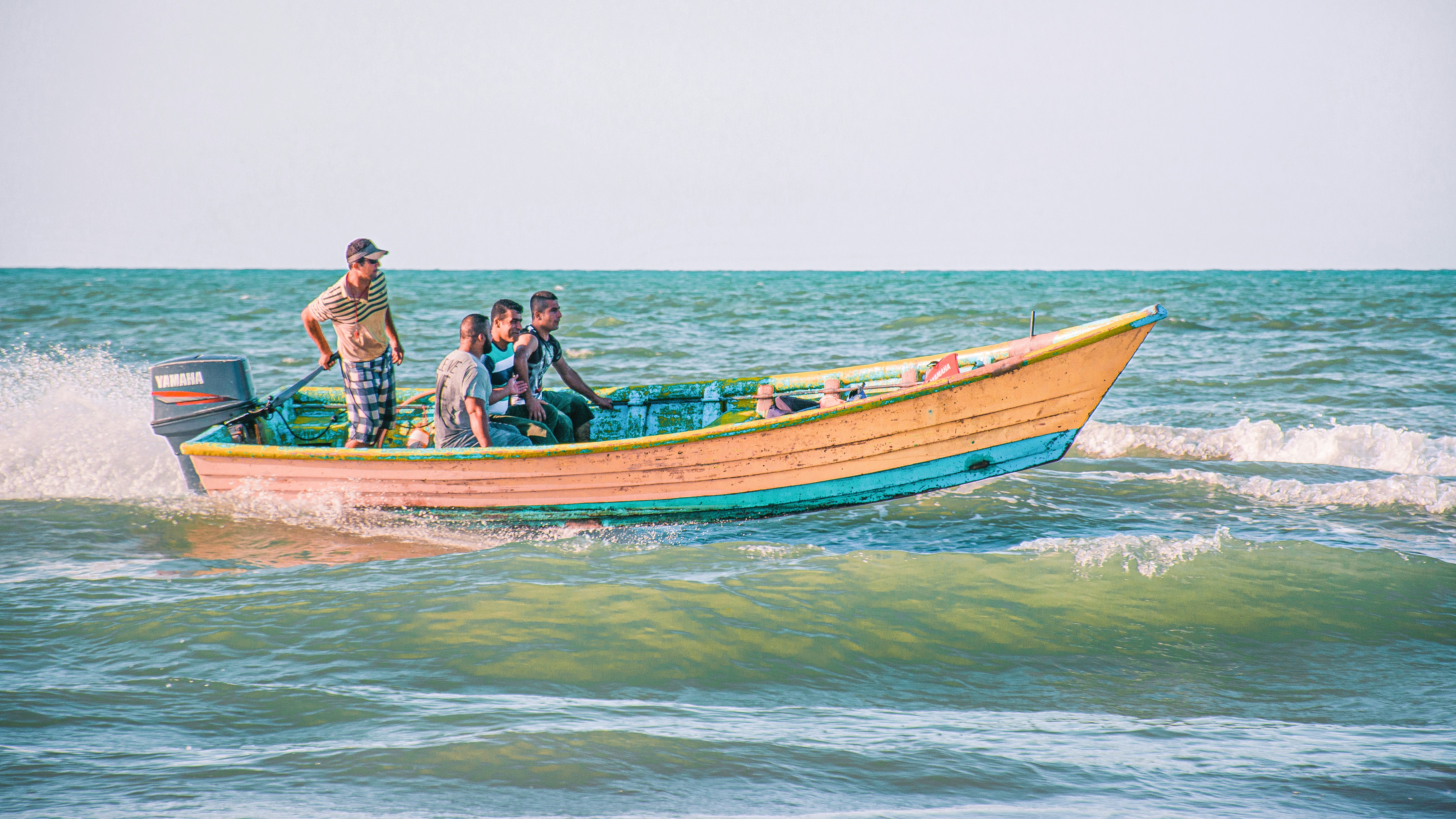 People riding on brown and white boat on sea during daytime photo ...